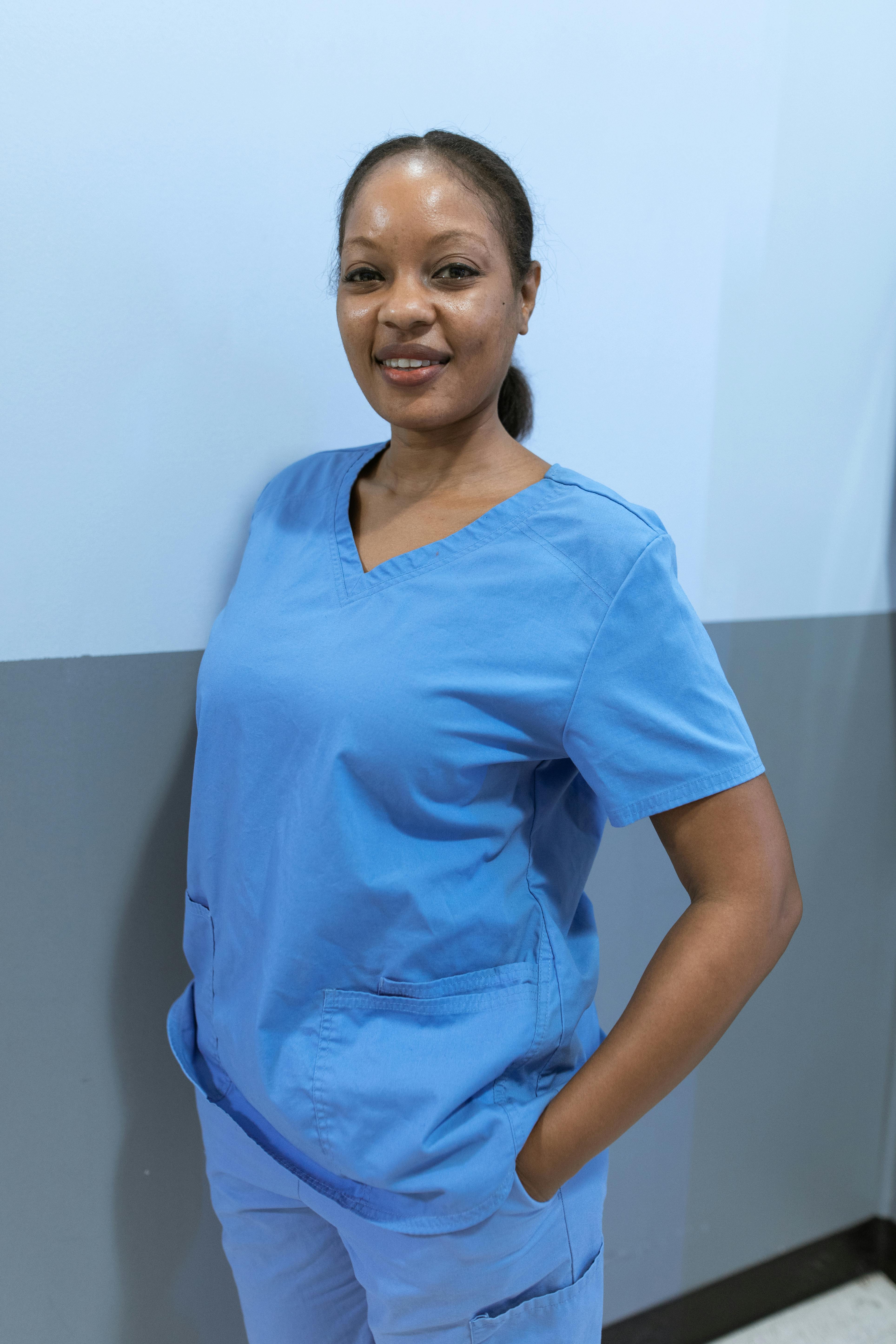 Nurse Wearing a Scrub Suit Smiling · Free Stock Photo