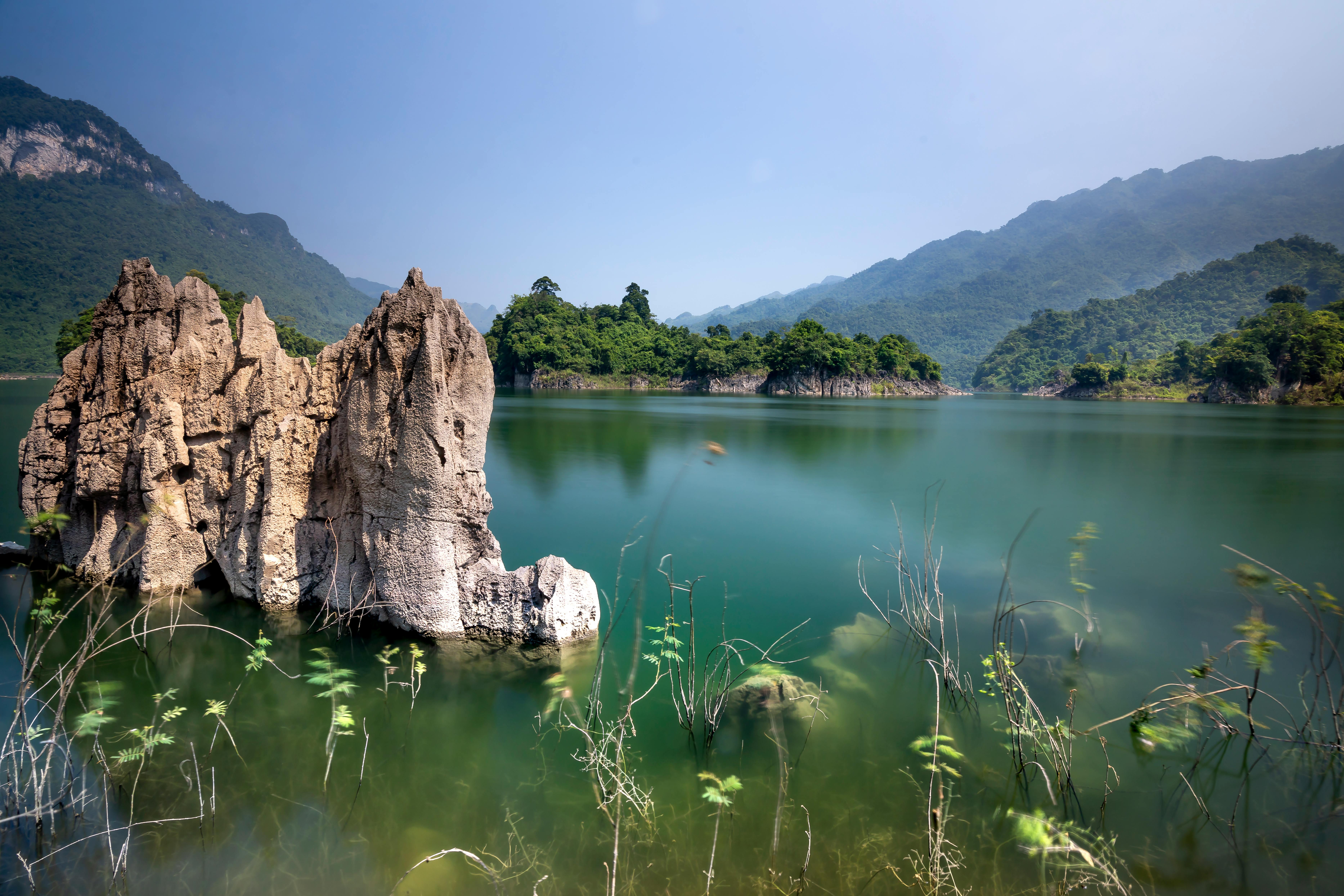 Breathtaking landscape of lake with rocks near green hills · Free Stock ...