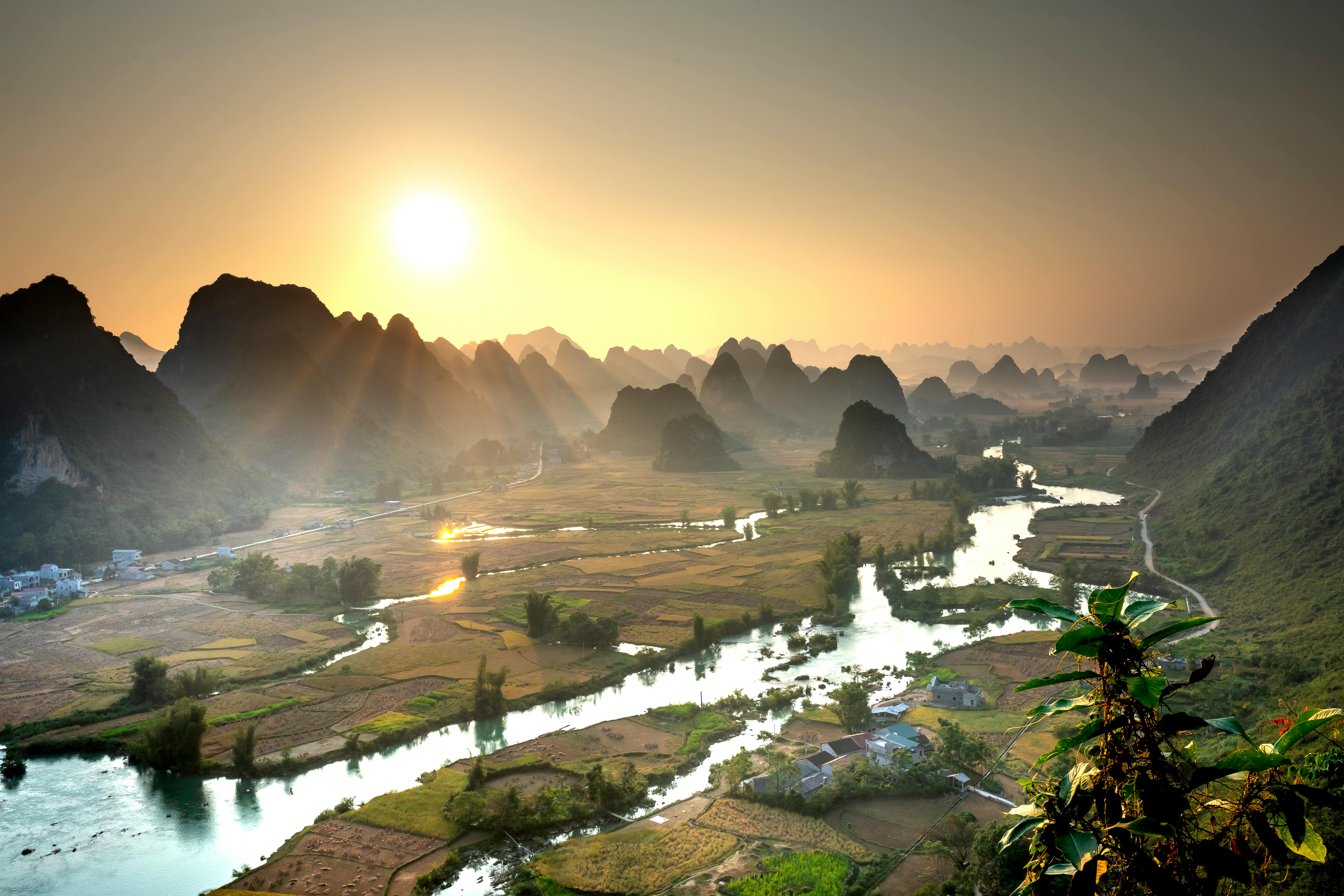 Picturesque view of highlands with river near fields at sunset · Free ...