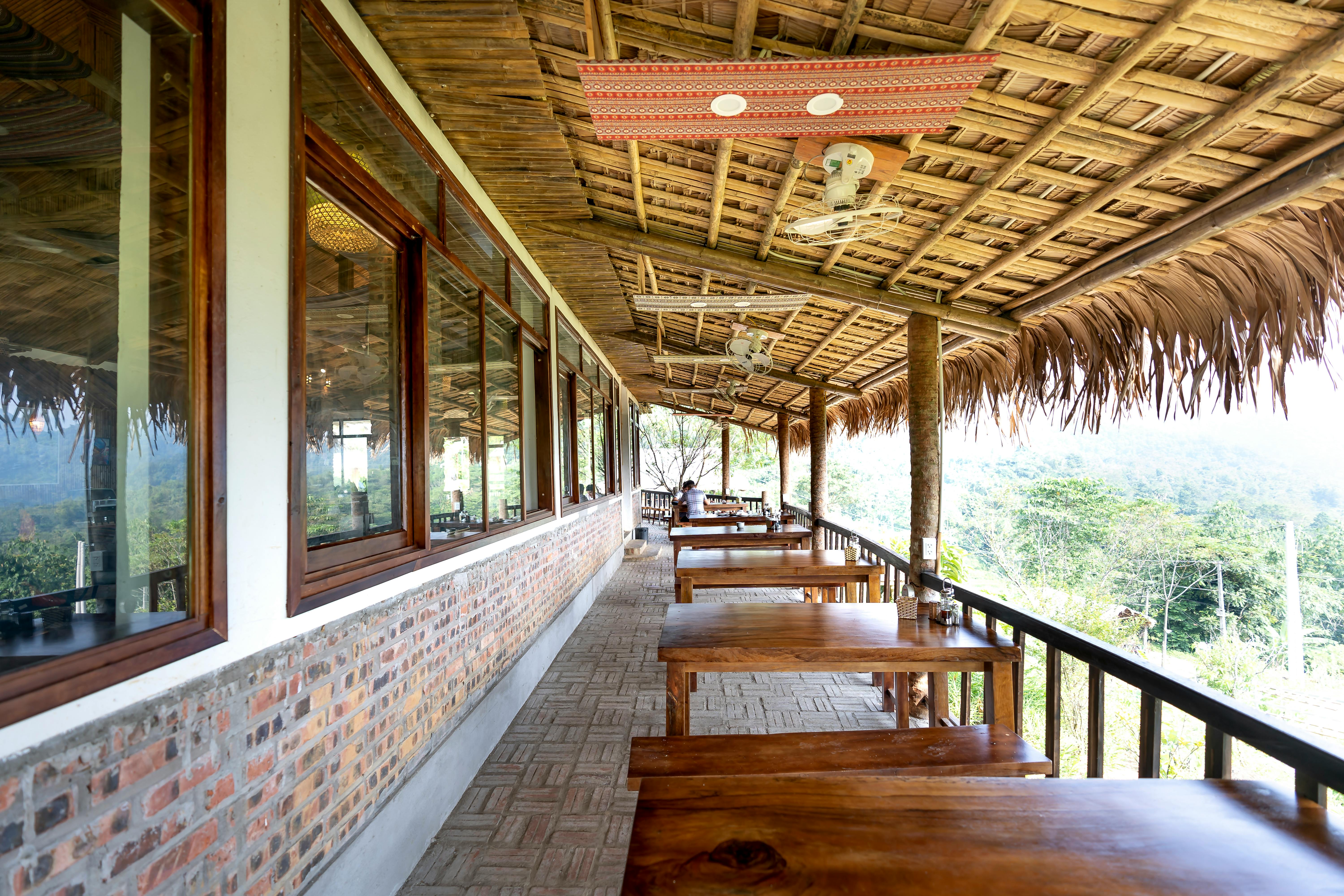 Wooden table on terrace of cafeteria · Free Stock Photo