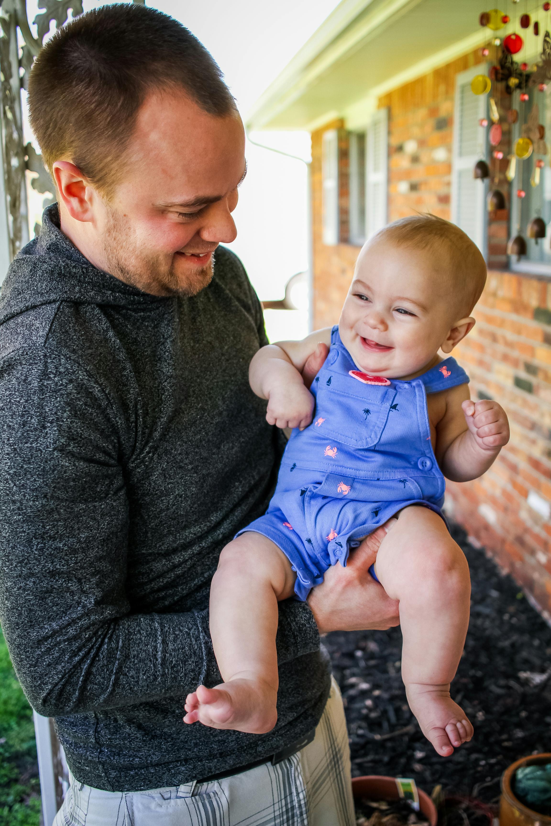 A Man Carrying a Baby on his Shoulder · Free Stock Photo