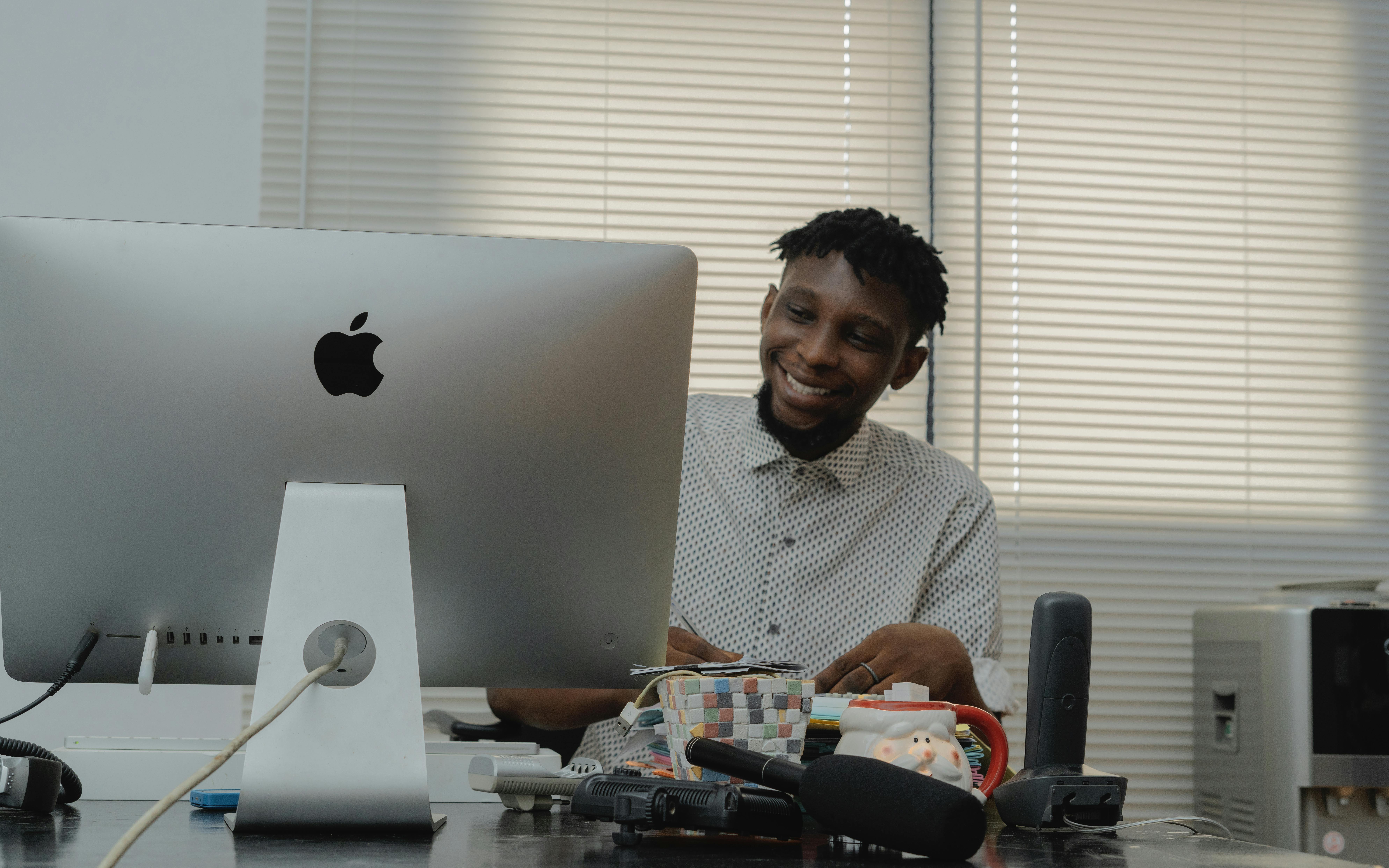 A Man Smiling Looking the Monitor · Free Stock Photo