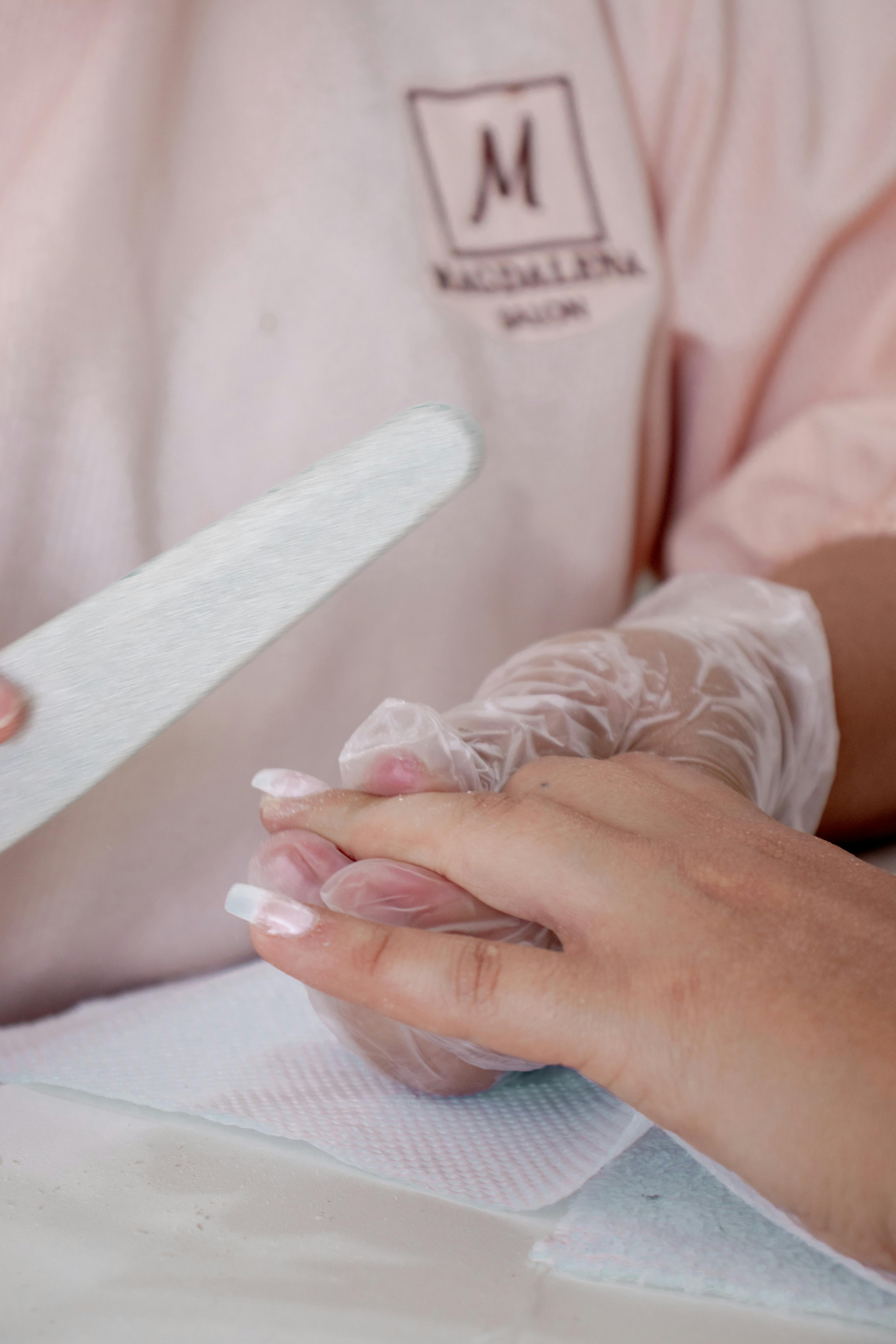 Photo of a Person's Hand Getting a Manicure · Free Stock Photo