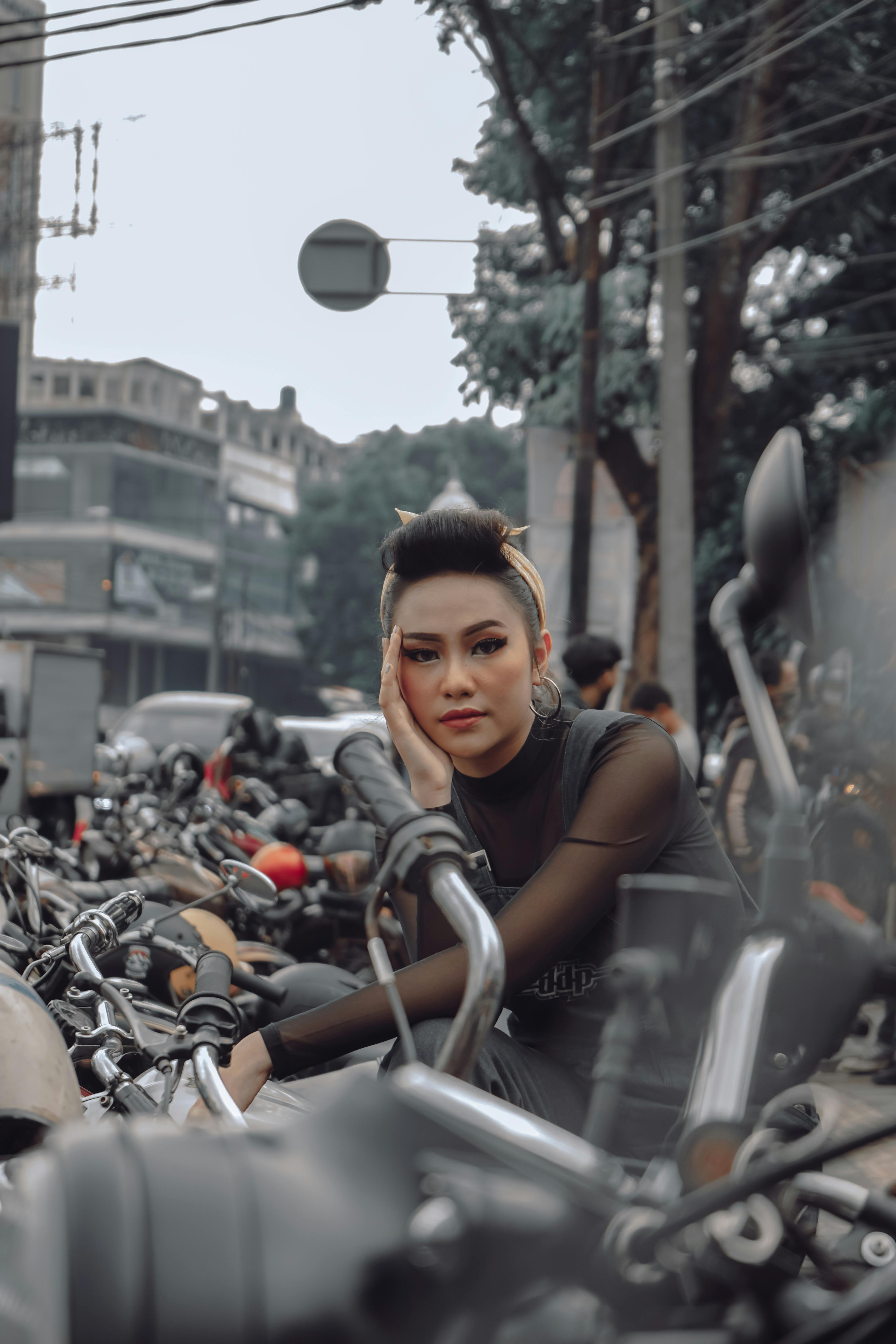 Asian female biker on motorbike in town · Free Stock Photo