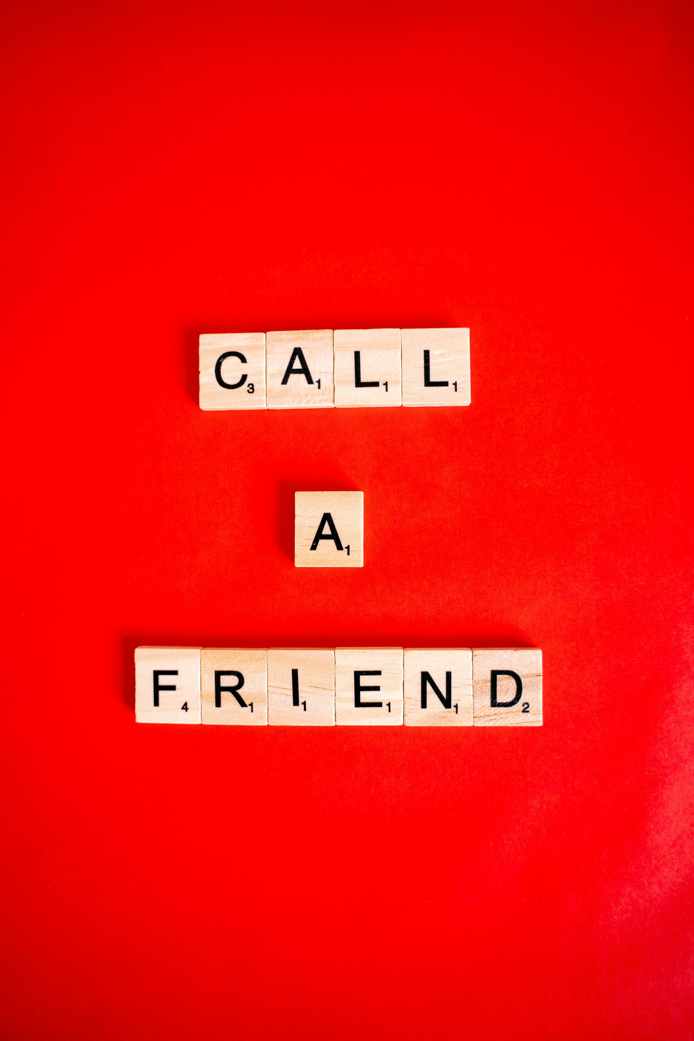 Photograph of Call a Friend Scrabble Tiles · Free Stock Photo