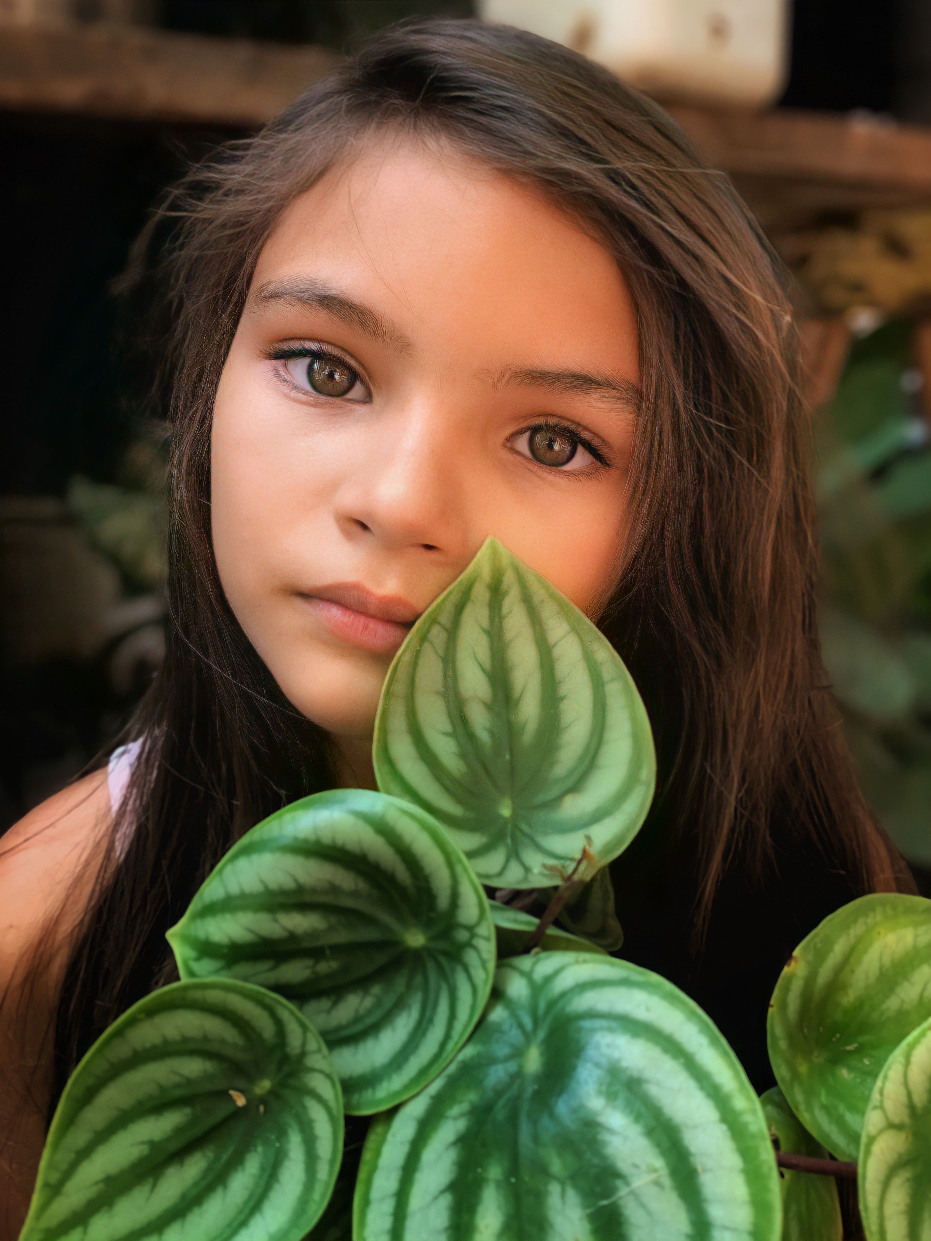 Portrait of a Girl Near Green Leaves · Free Stock Photo