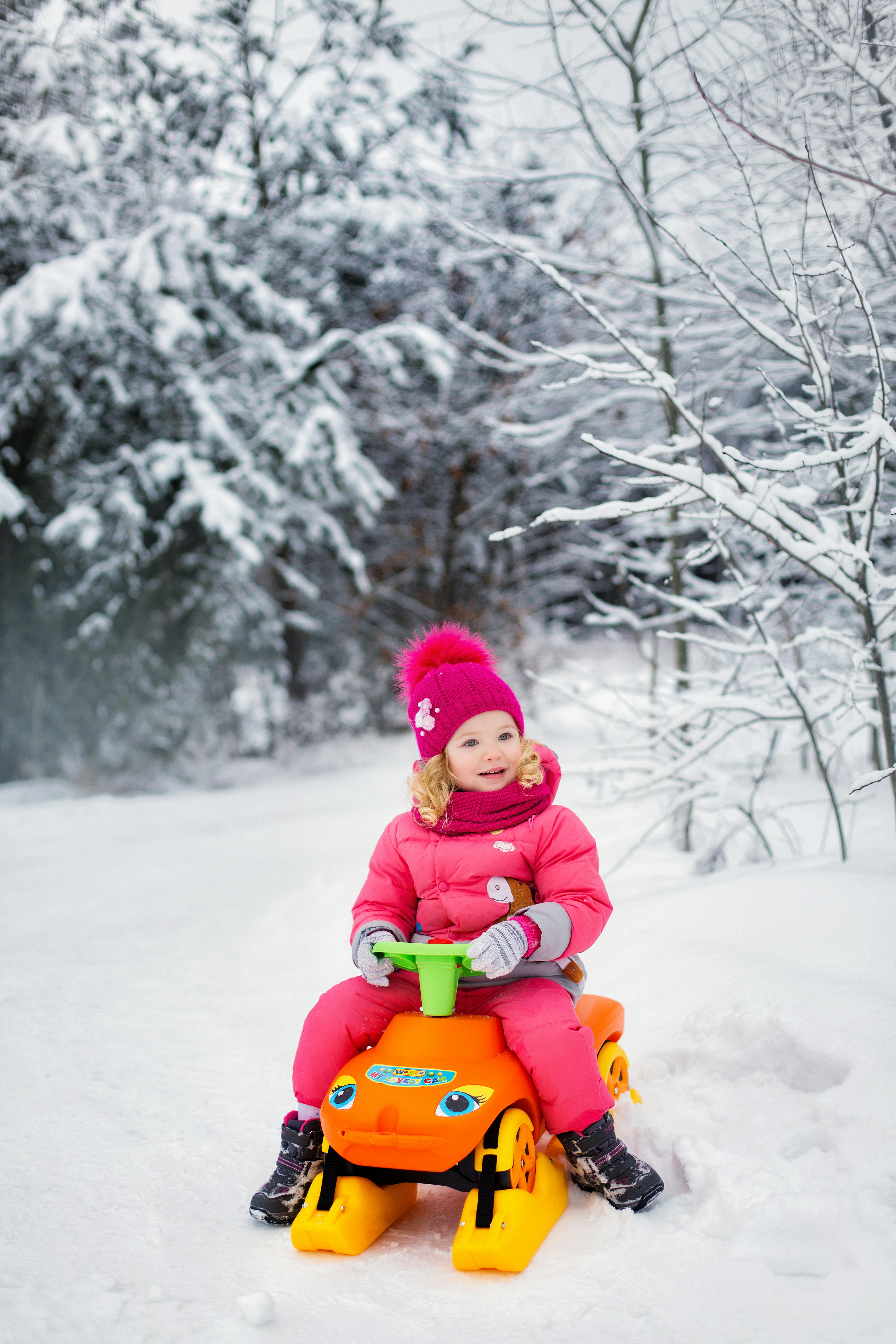 Kid on a Snowmobile Toy · Free Stock Photo