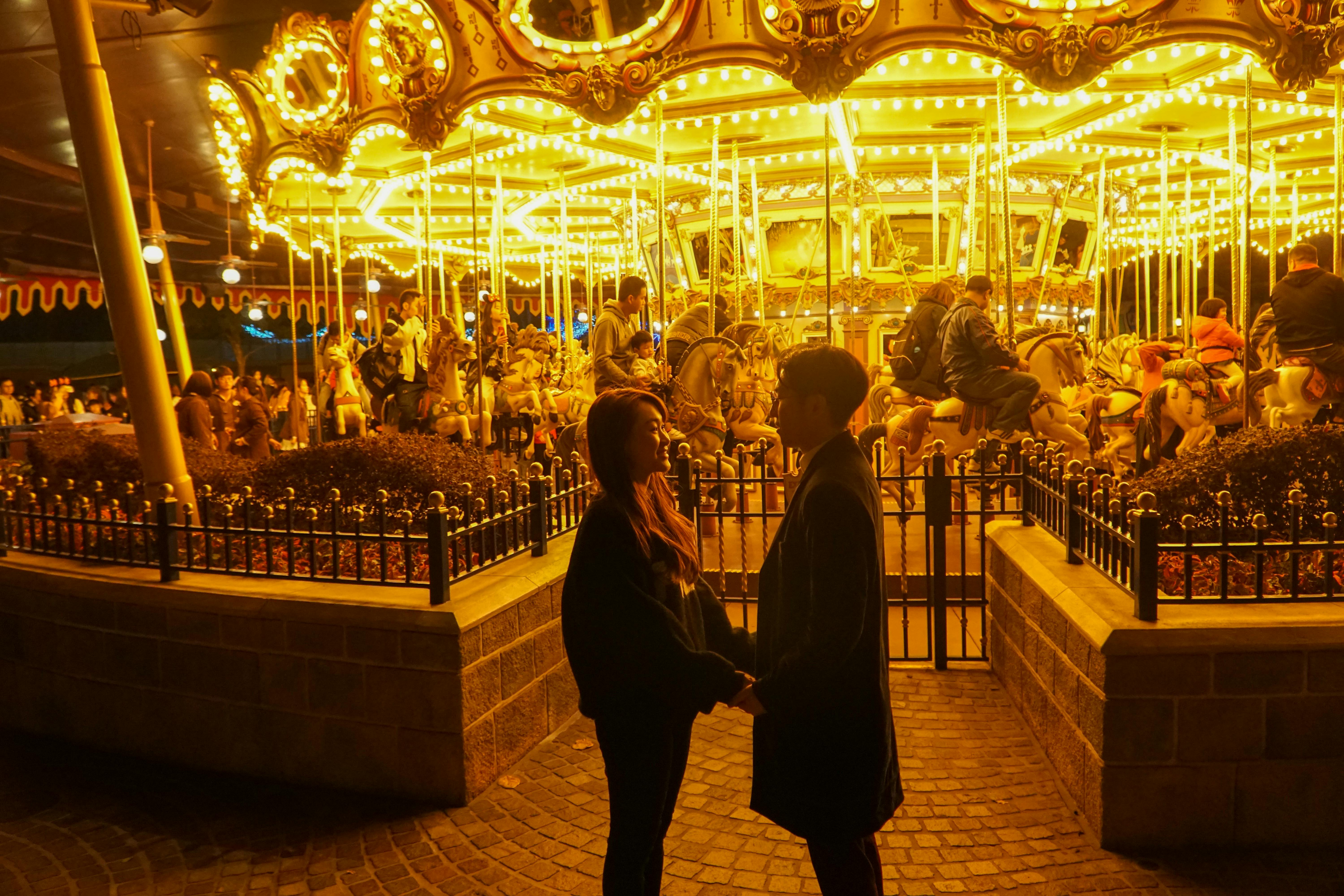 Girl Standing Near Carousel · Free Stock Photo