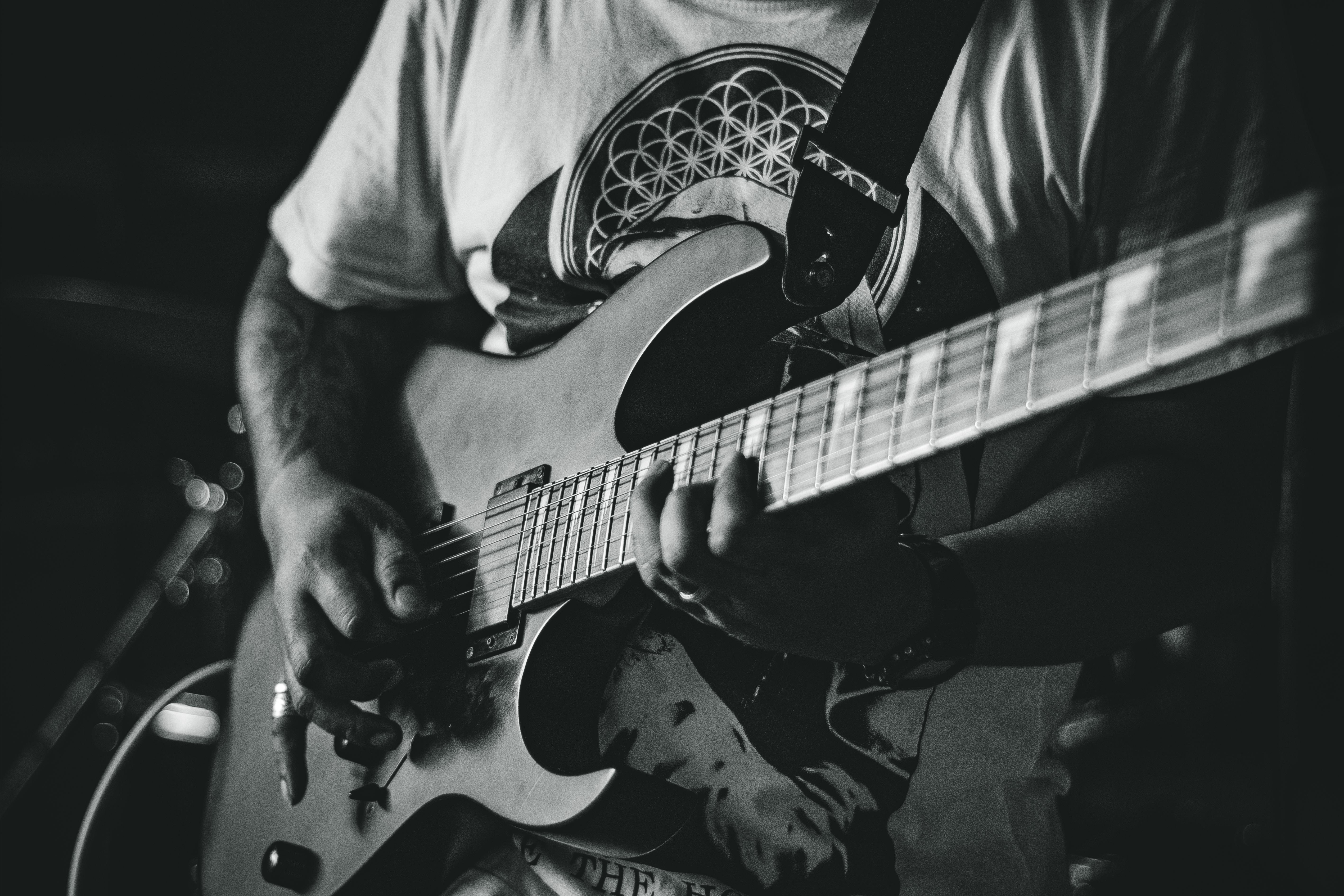 Grayscale Photo of Person Playing Electric Guitar · Free Stock Photo