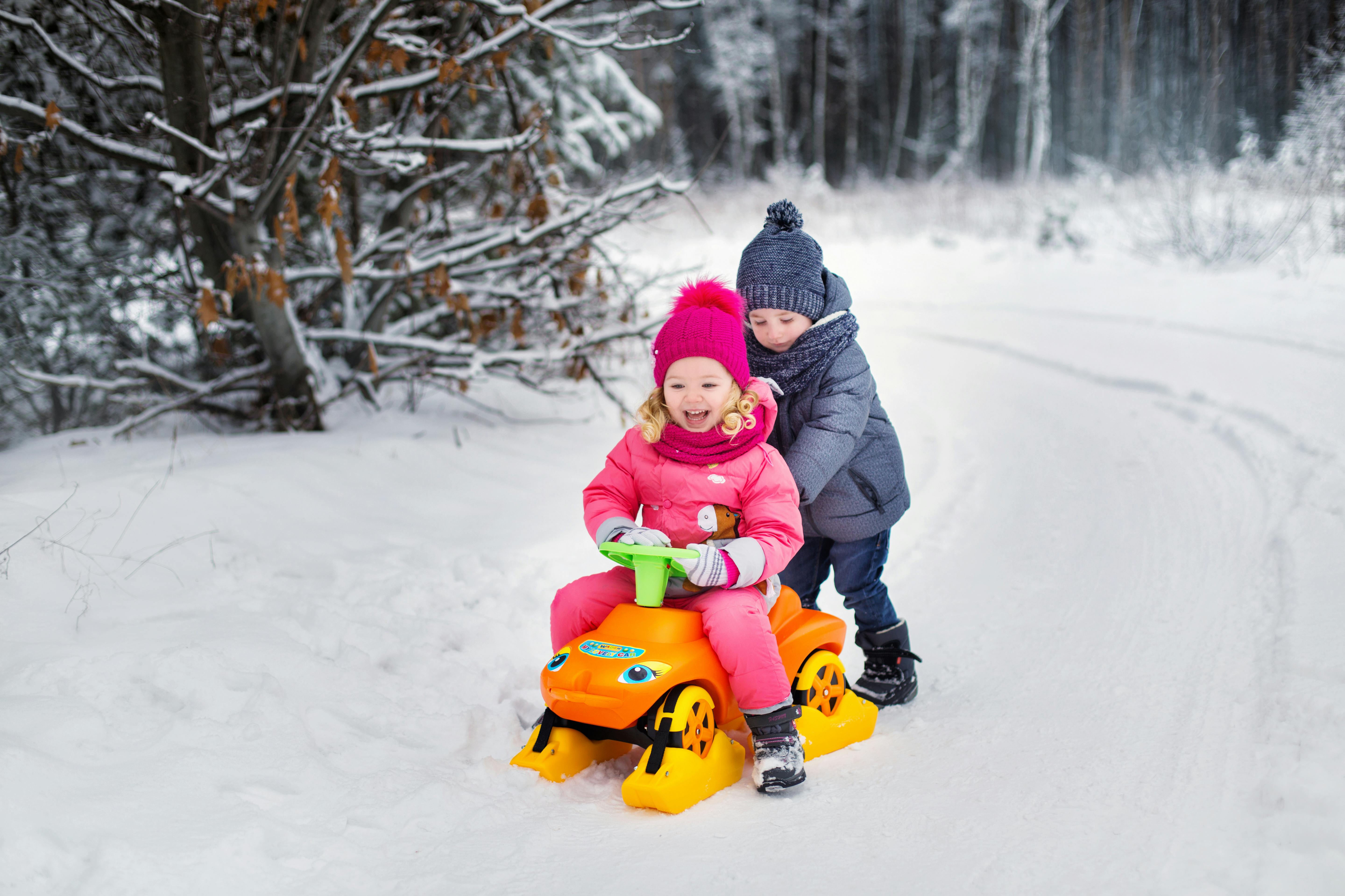 A Boy Riding on a Plastic Toy Car · Free Stock Photo