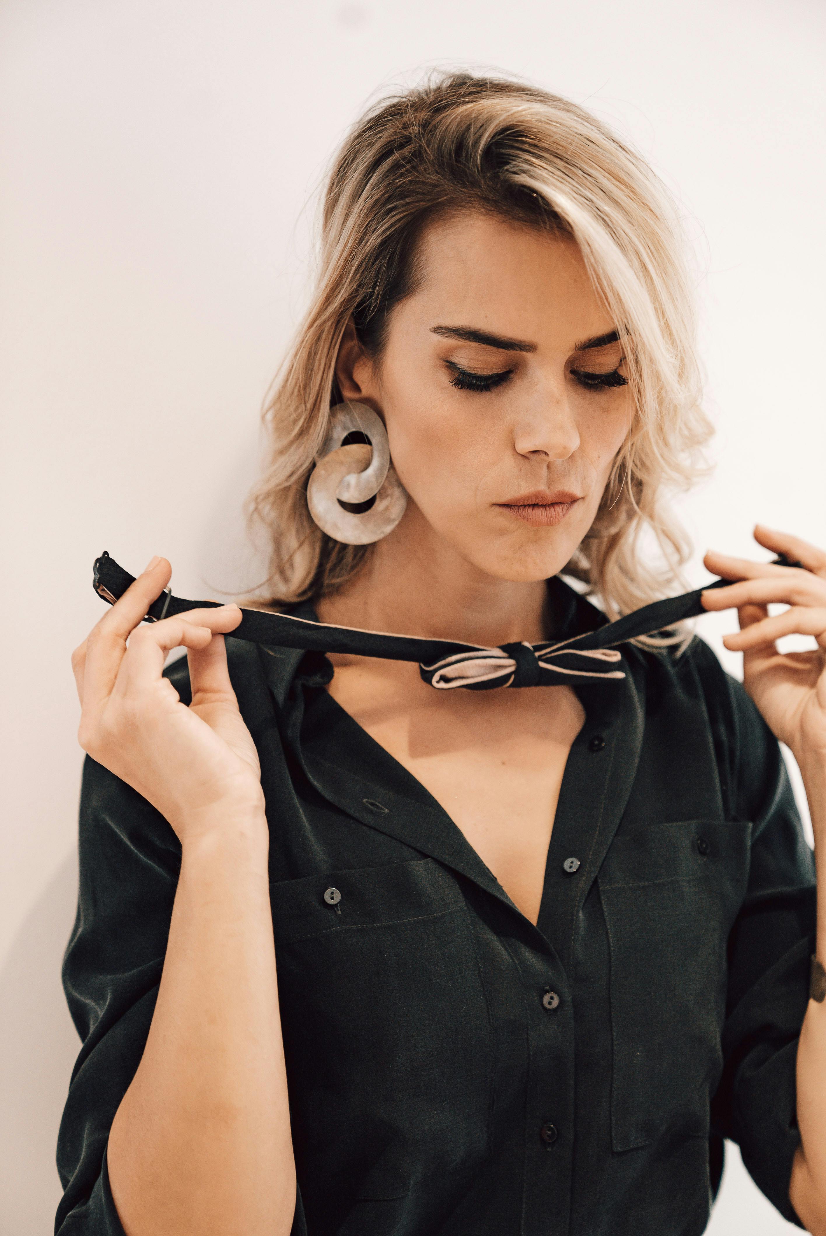 Stylish woman putting accessory on neck · Free Stock Photo