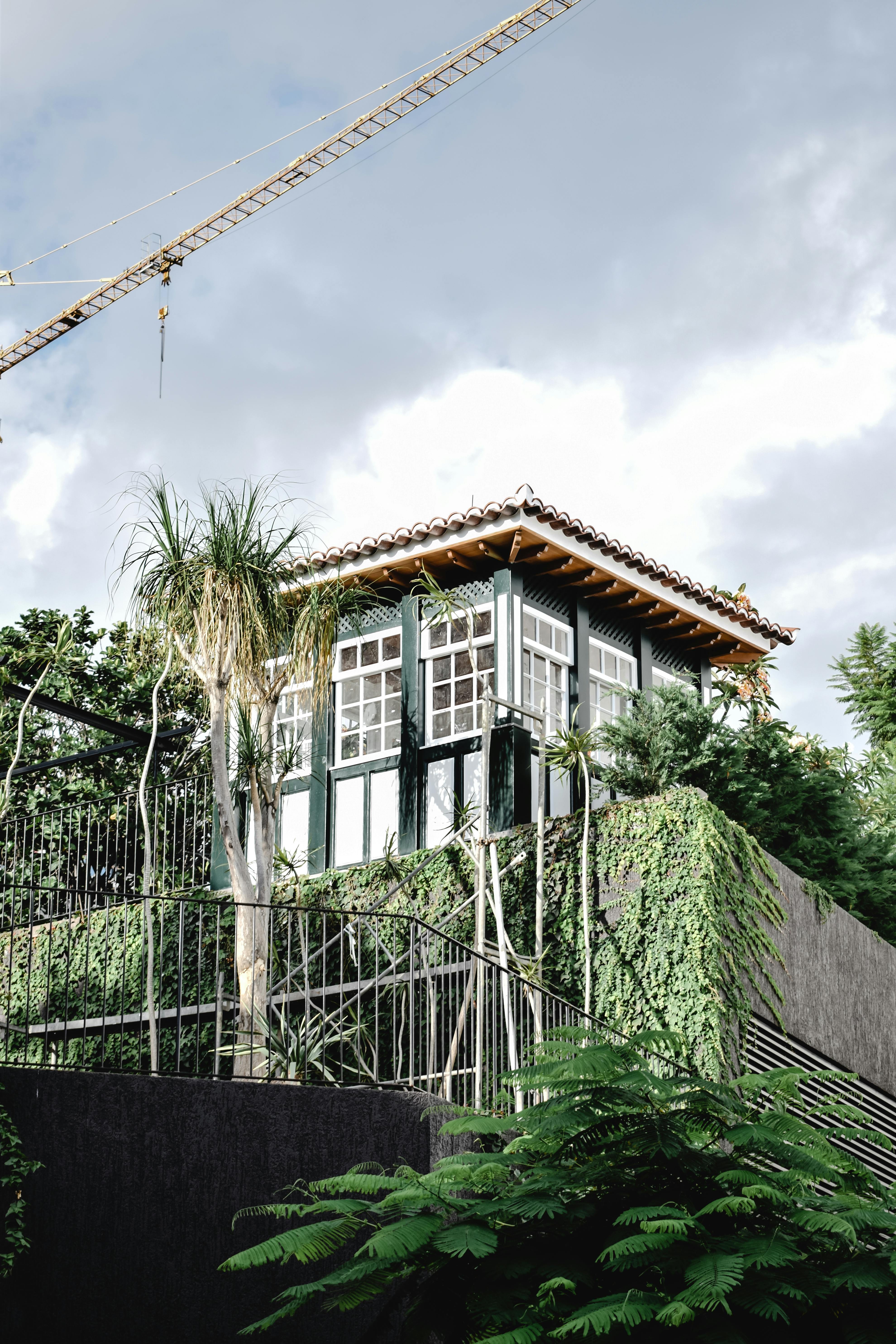 Crane over a House on Top of the Hill · Free Stock Photo