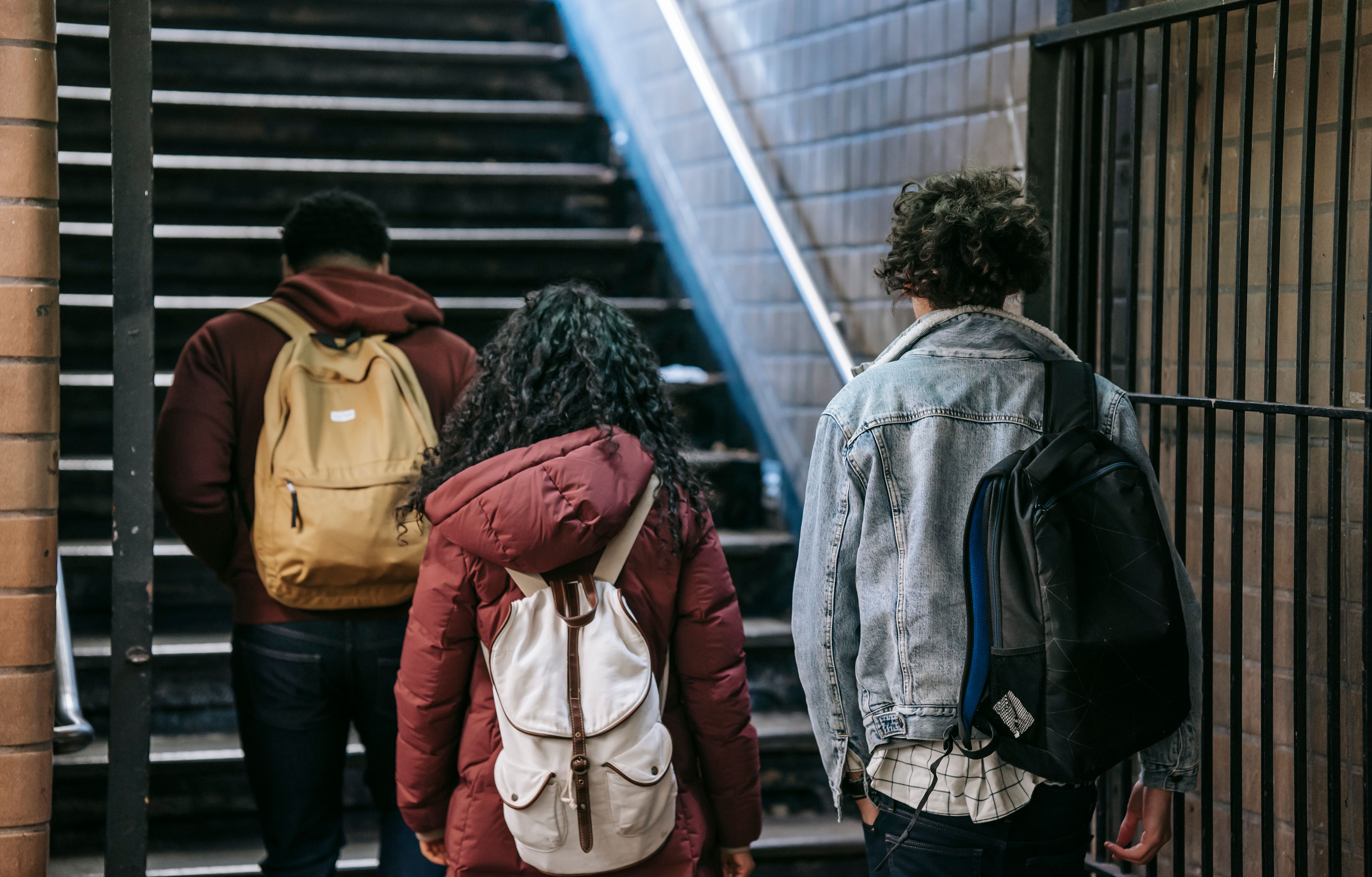 Group of young students walking near stairs · Free Stock Photo