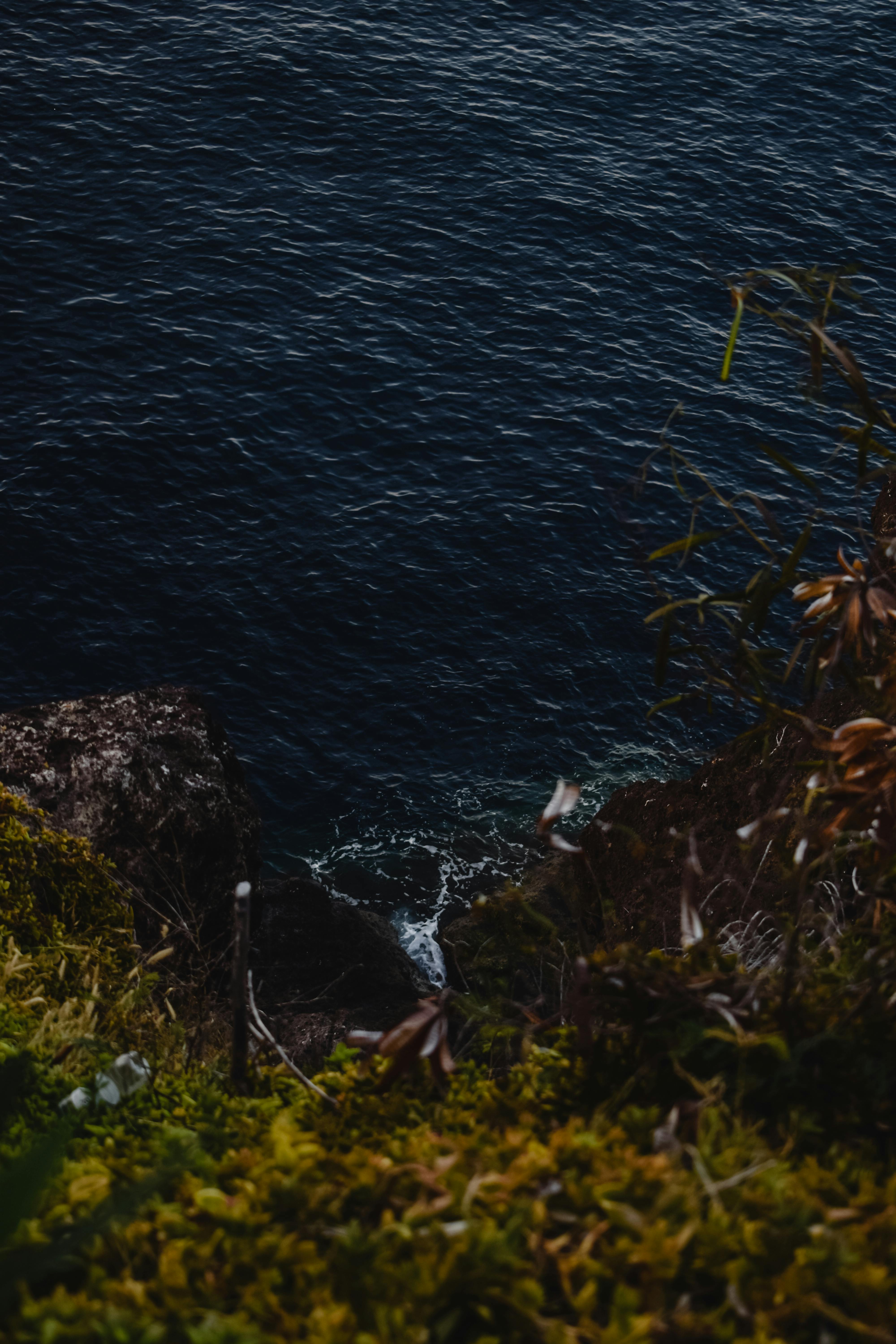 Photo of a Stone Cliff over Water · Free Stock Photo