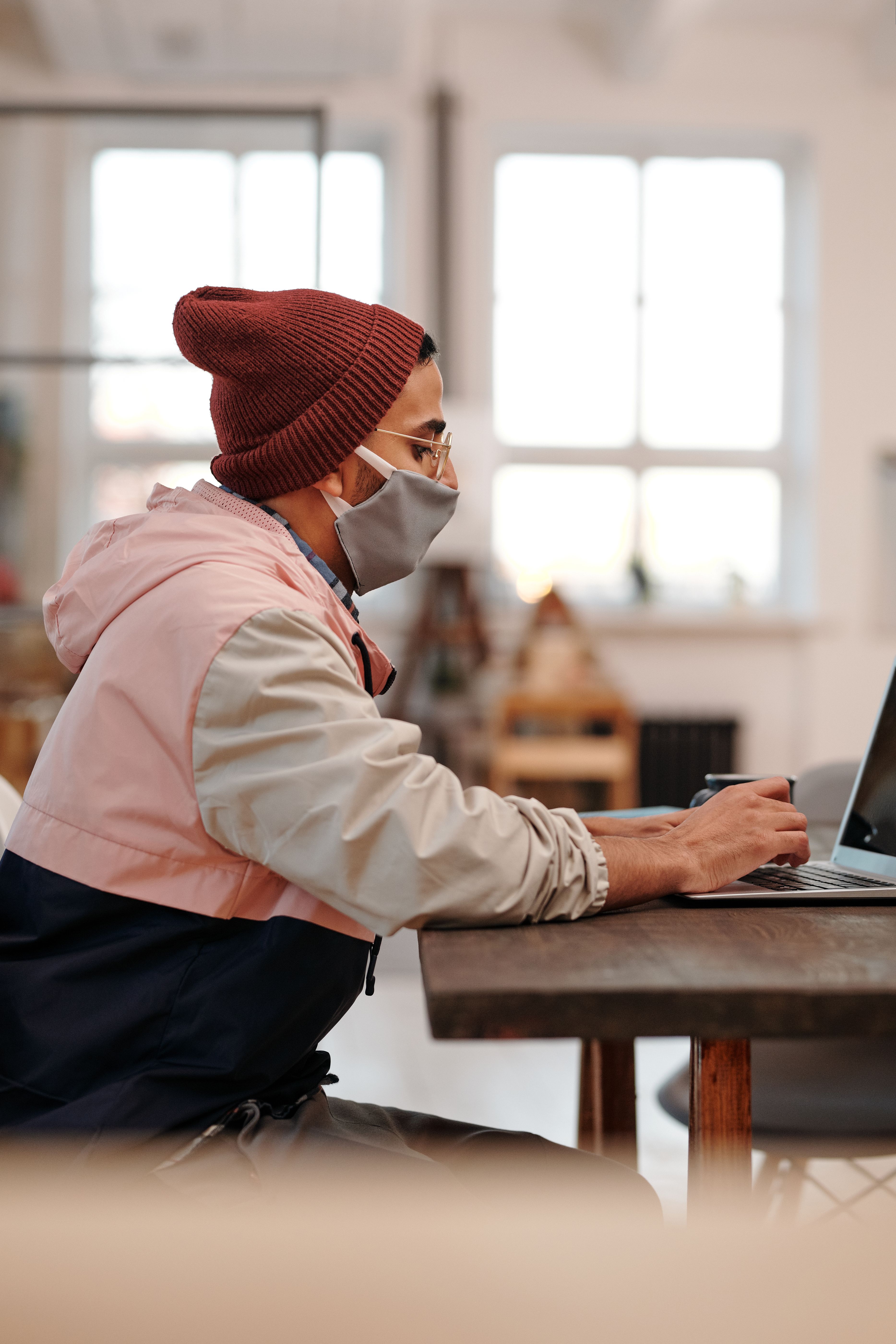 A Man in Hoodie Jacket Using a Laptop · Free Stock Photo