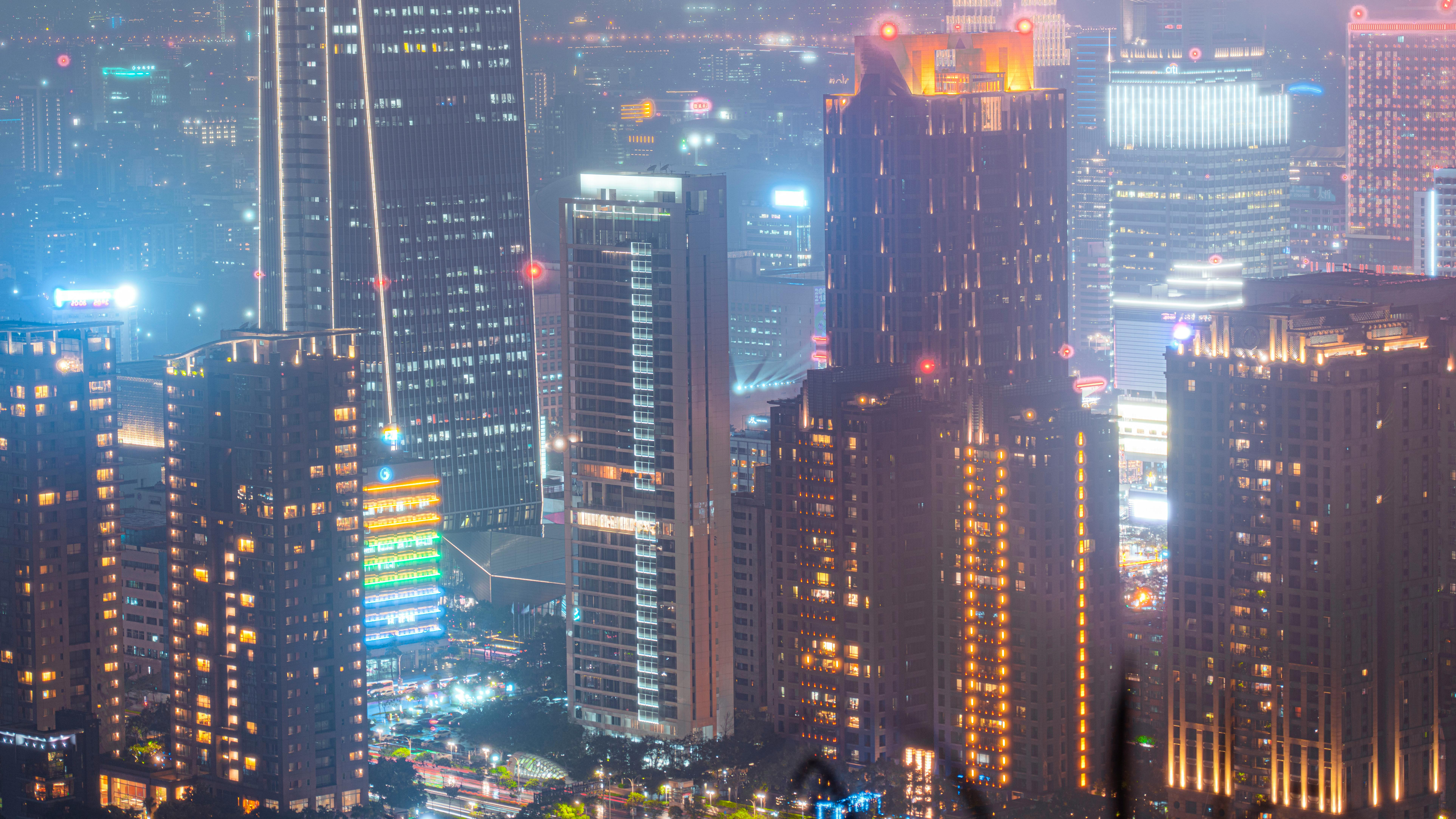 Glowing buildings in city at night · Free Stock Photo