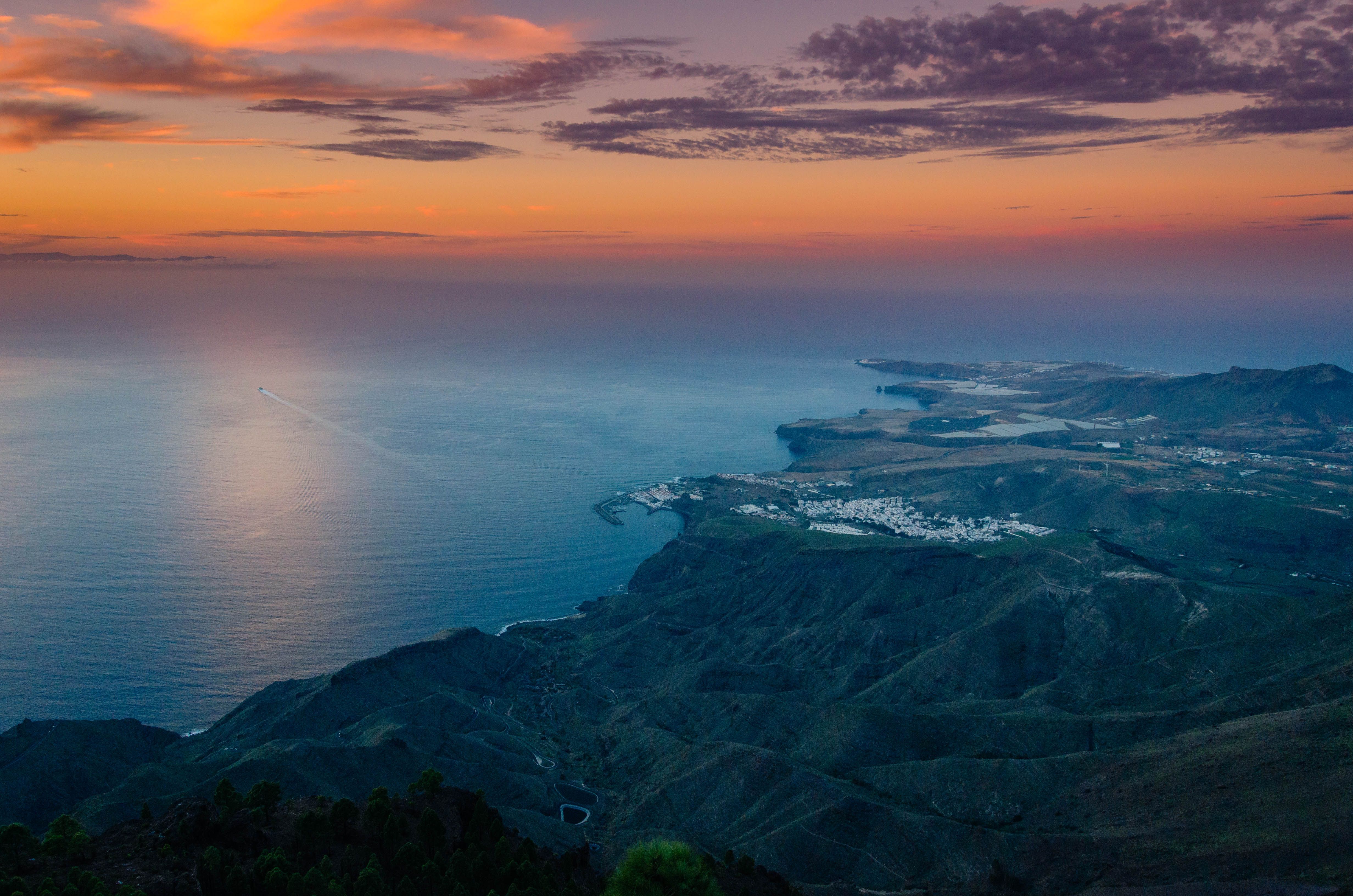 Aerial View of Mountains near the Sea during Sunset · Free Stock Photo