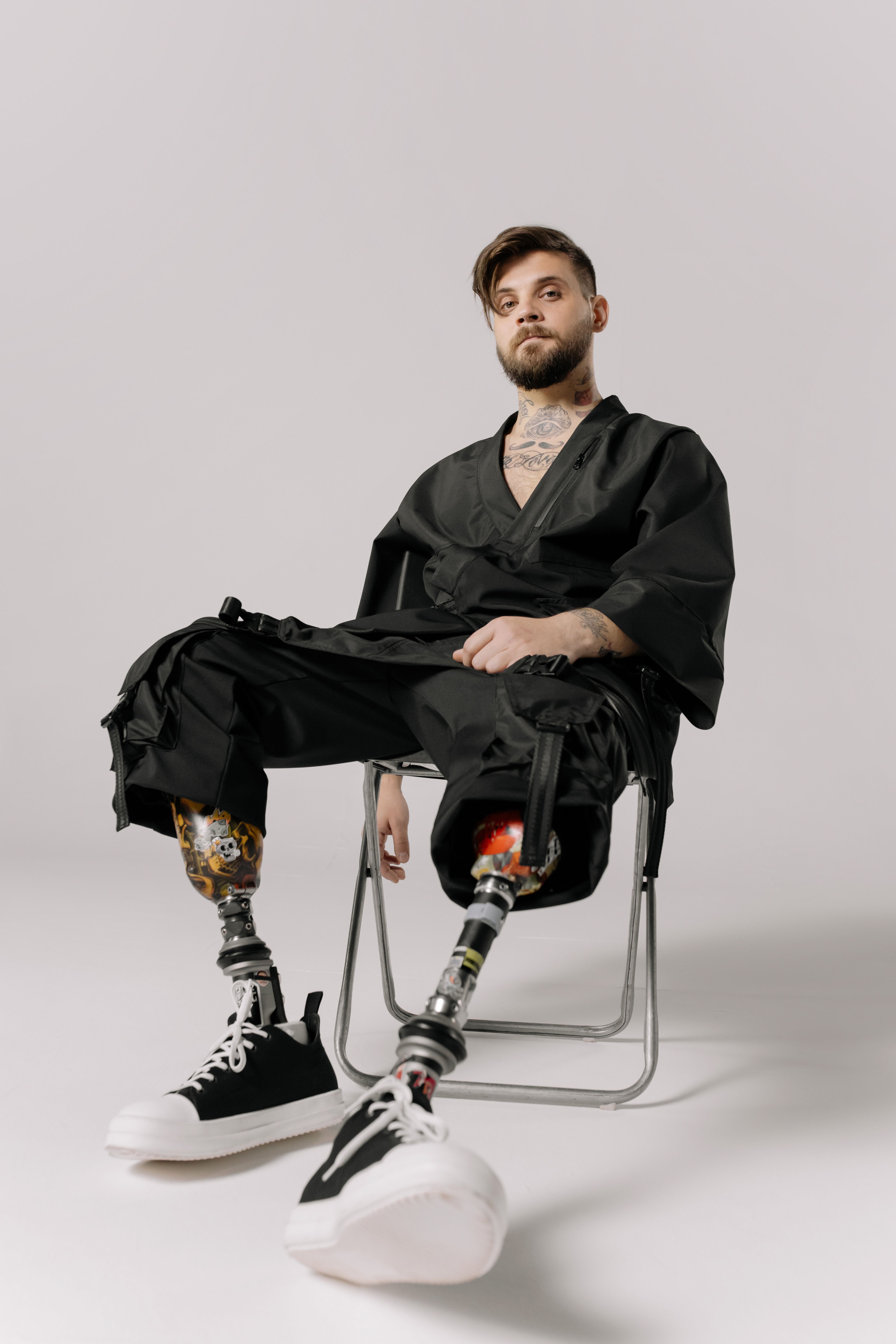 A Man With Prosthesis Sitting on a Chair · Free Stock Photo