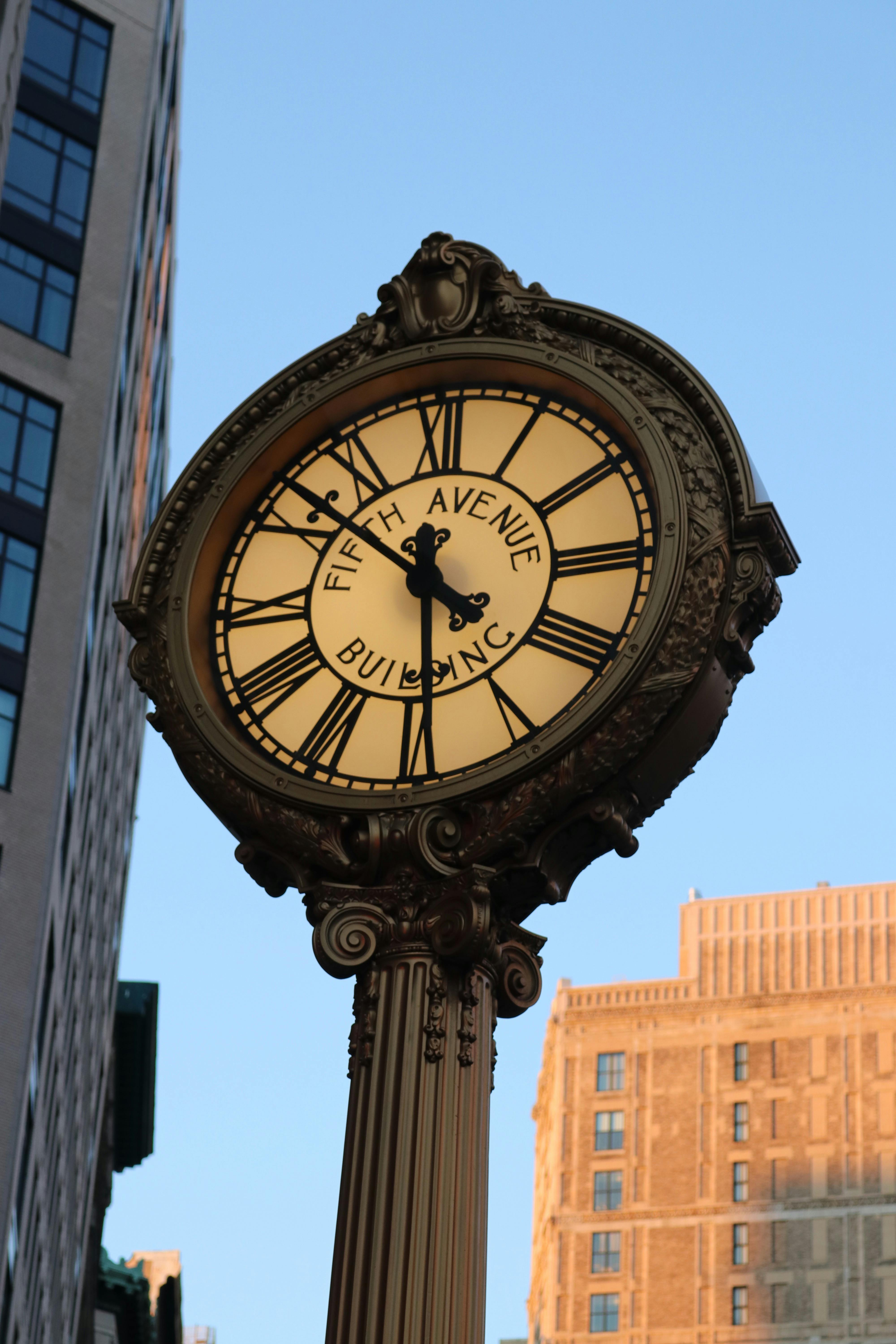 Classic clock tower in downtown with skyscrapers · Free Stock Photo