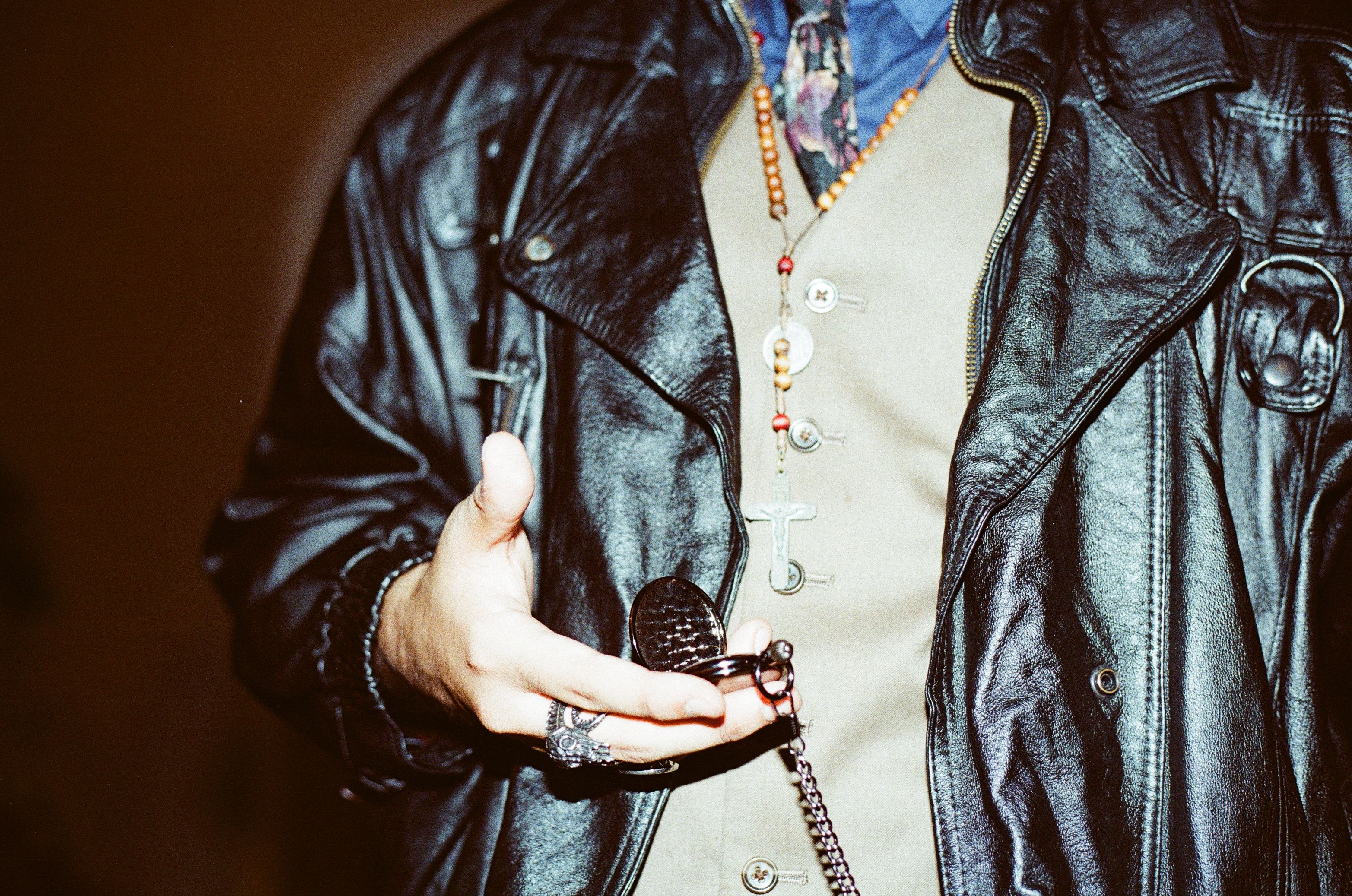 Person in Black Leather Jacket Holding a Pocket Watch · Free Stock Photo