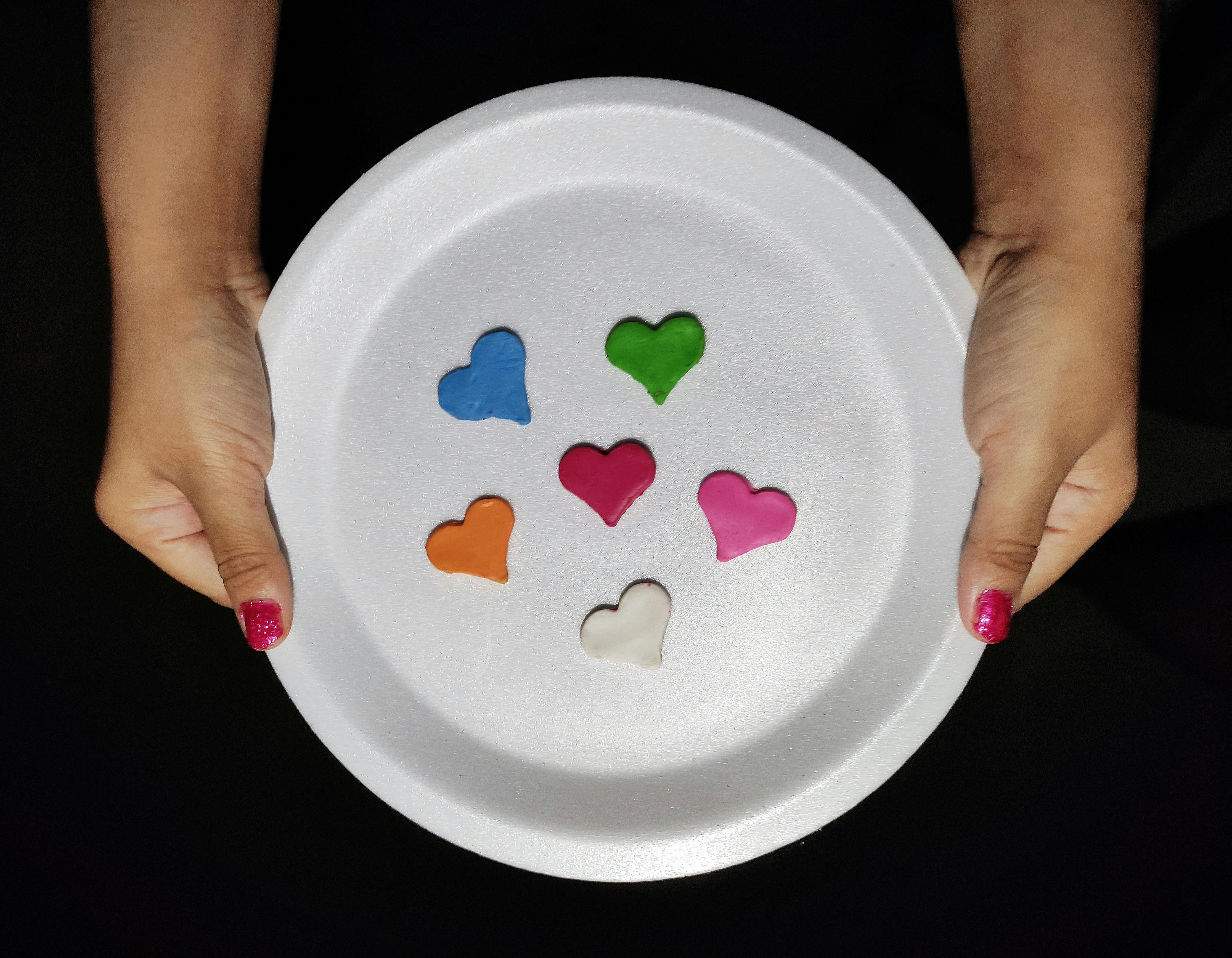 Top View of Hands Holding a Disposable Plates with Multicoloured ...