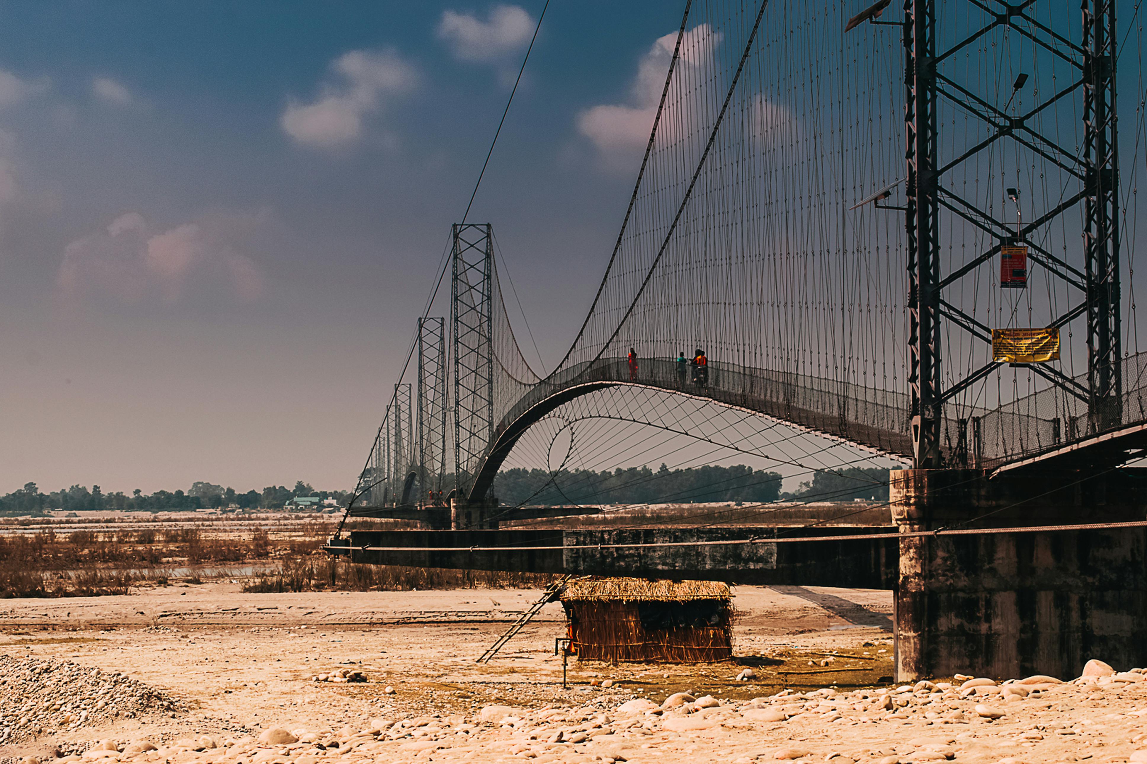 Bridge over Body of Water Under Cloudy Sky · Free Stock Photo
