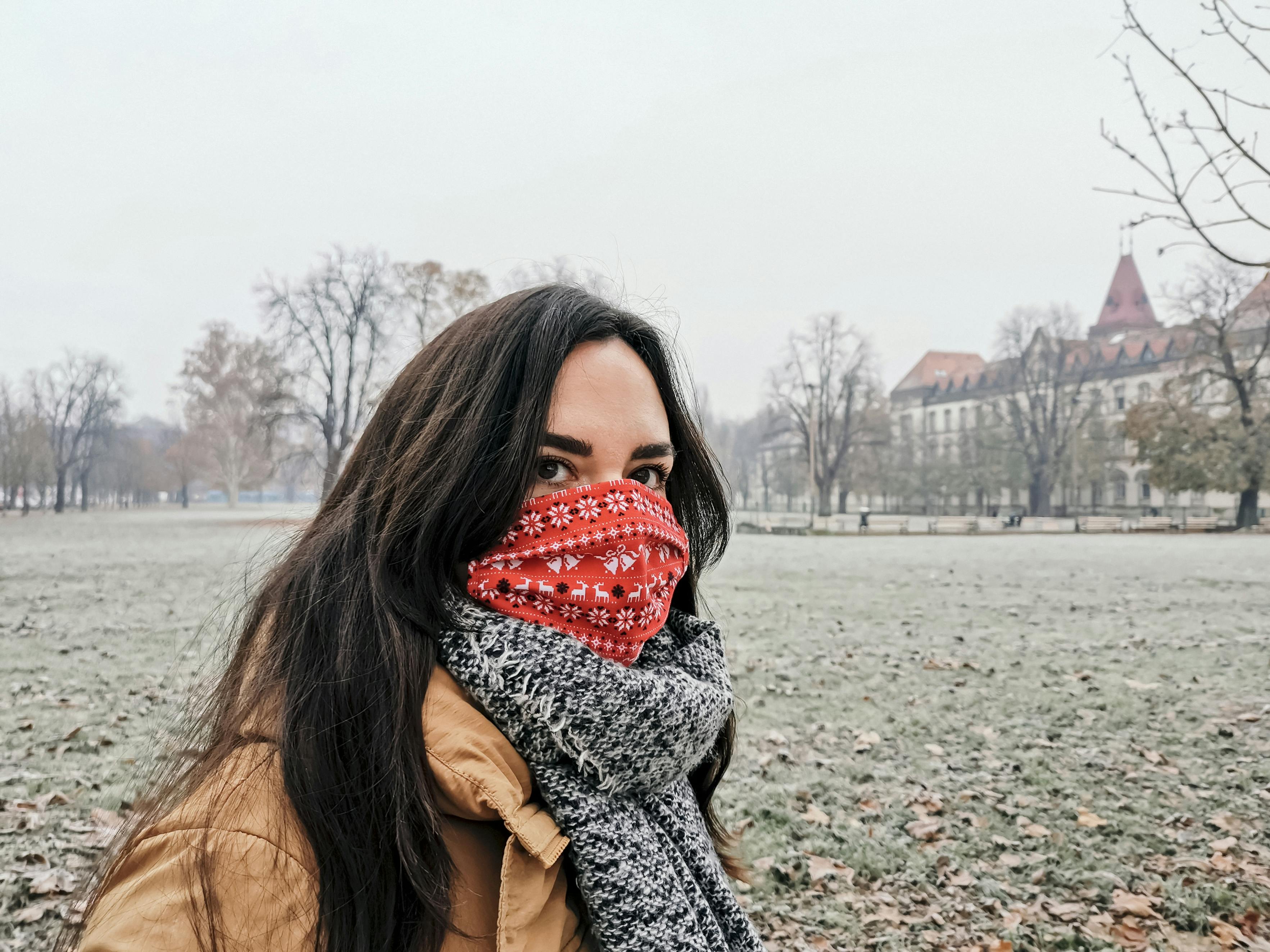 A Woman with a Gray Scarf Wearing Red and White Face Mask · Free Stock ...