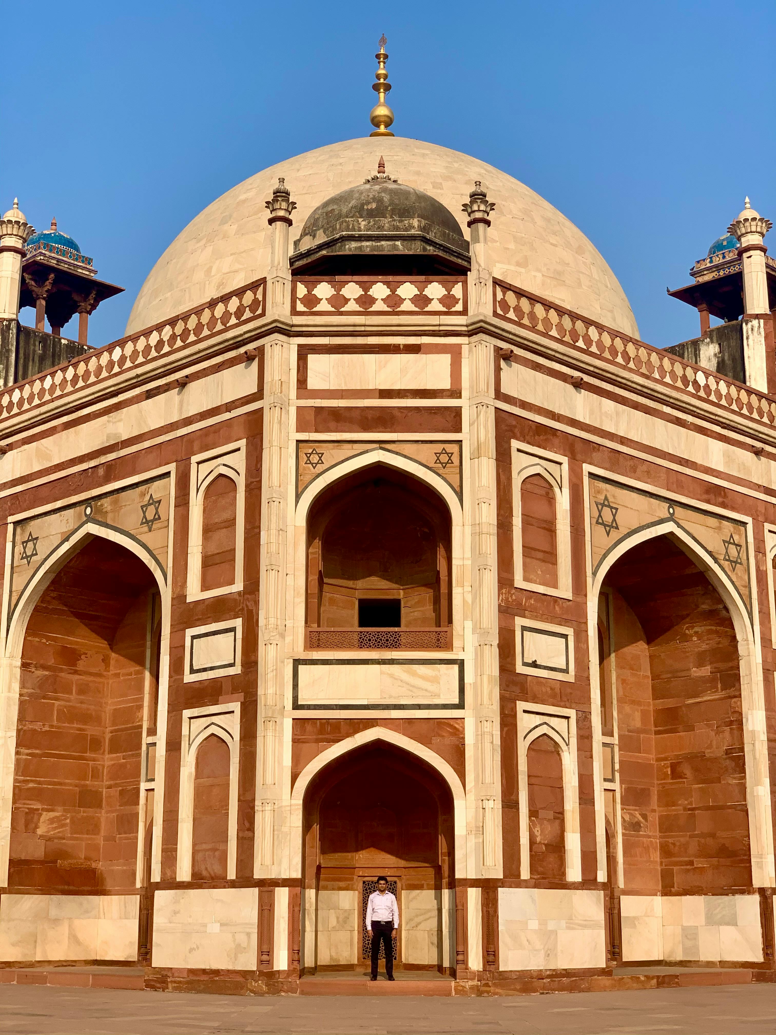 Man Standing near Traditional Mosque · Free Stock Photo
