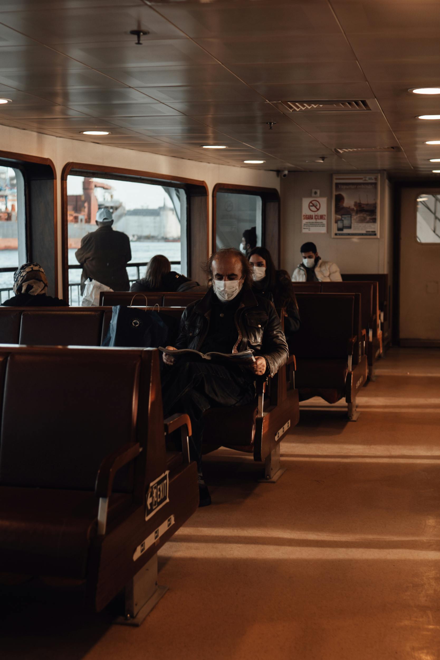 People on Ship Traveling on Water Beside Land · Free Stock Photo