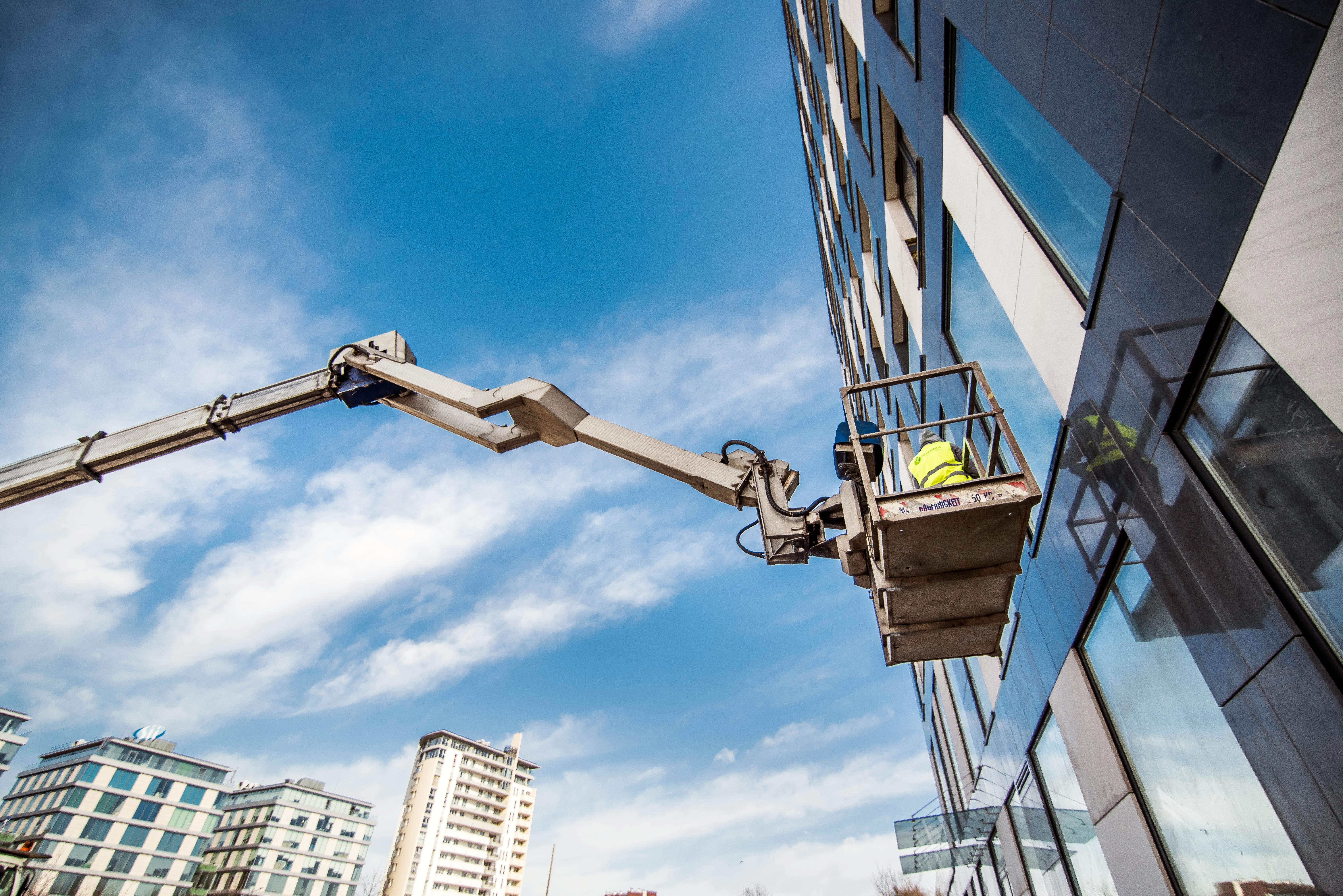Man Working High in Industrial Basket · Free Stock Photo