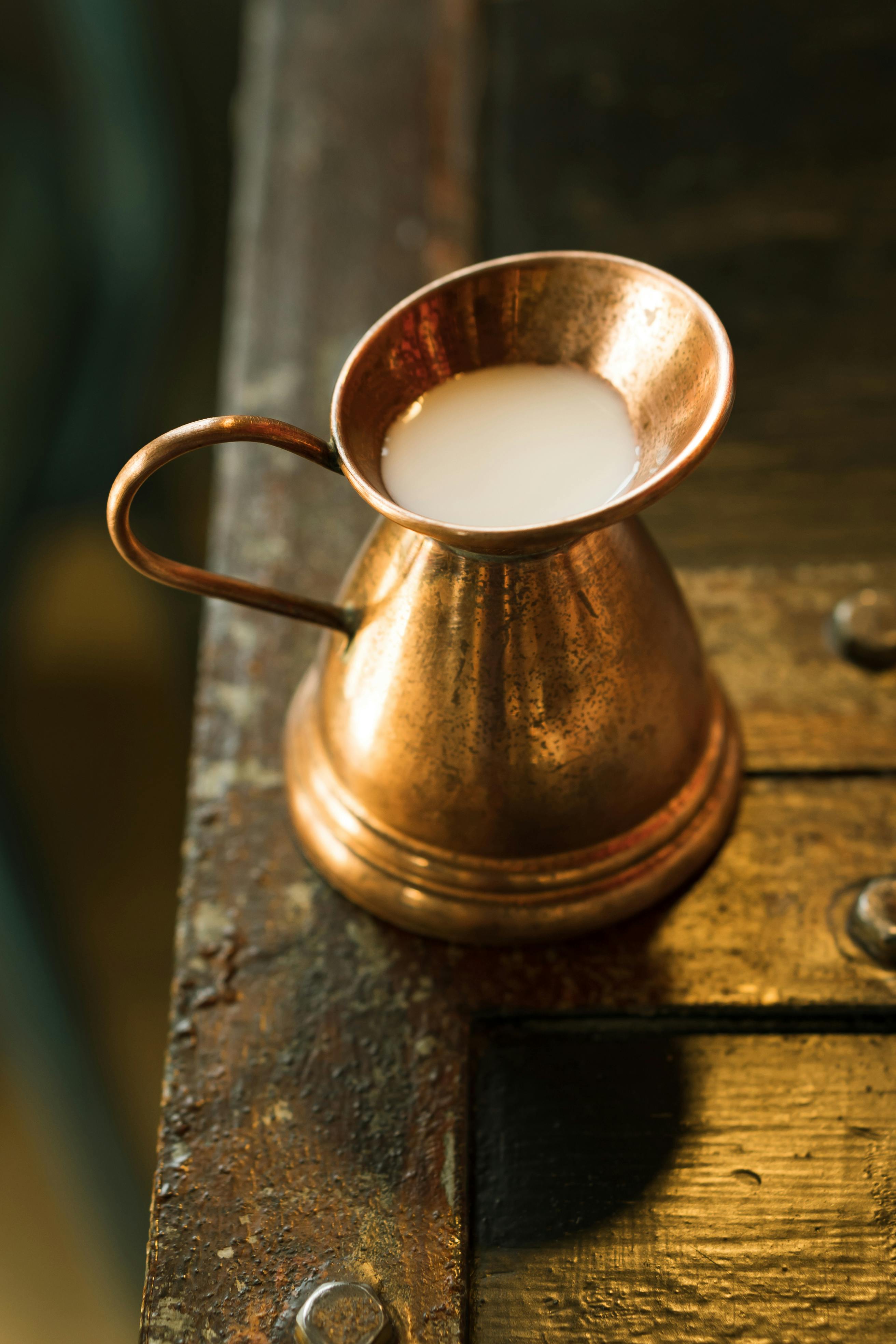 A Copper Pitcher with White Liquid · Free Stock Photo