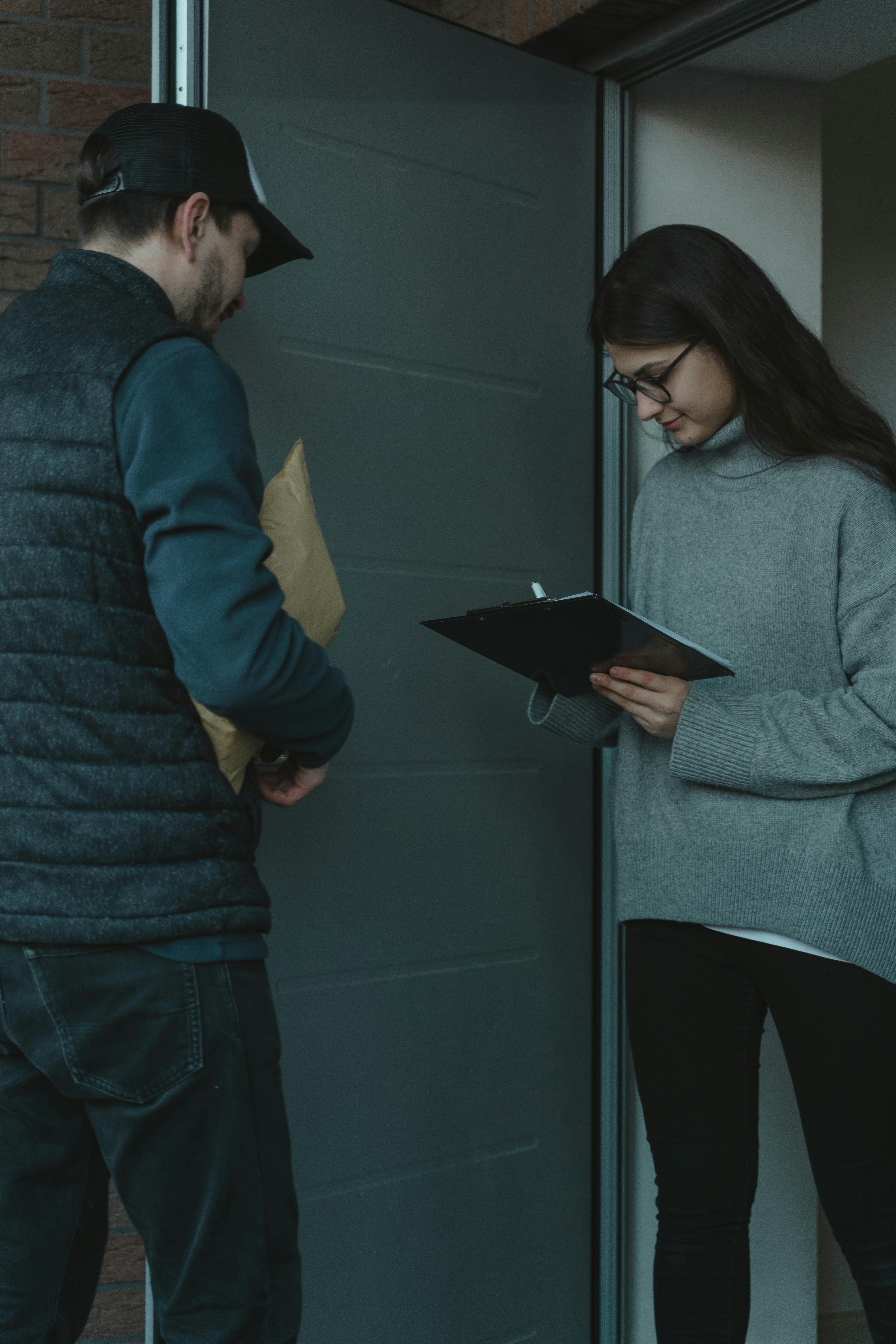 Woman Receiving Paper Bags from Courier · Free Stock Photo