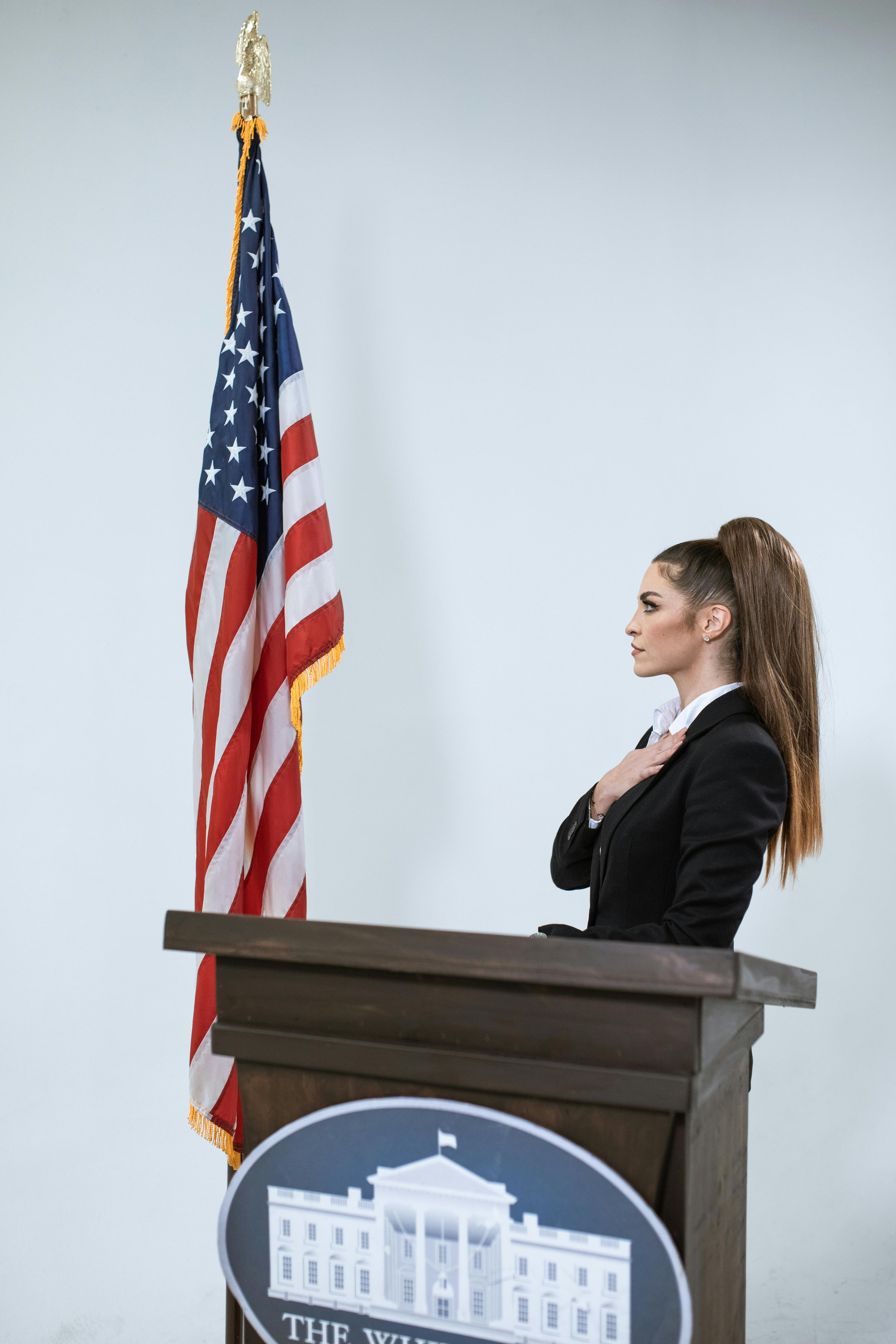 Woman in Red Dress Behind a Podium · Free Stock Photo