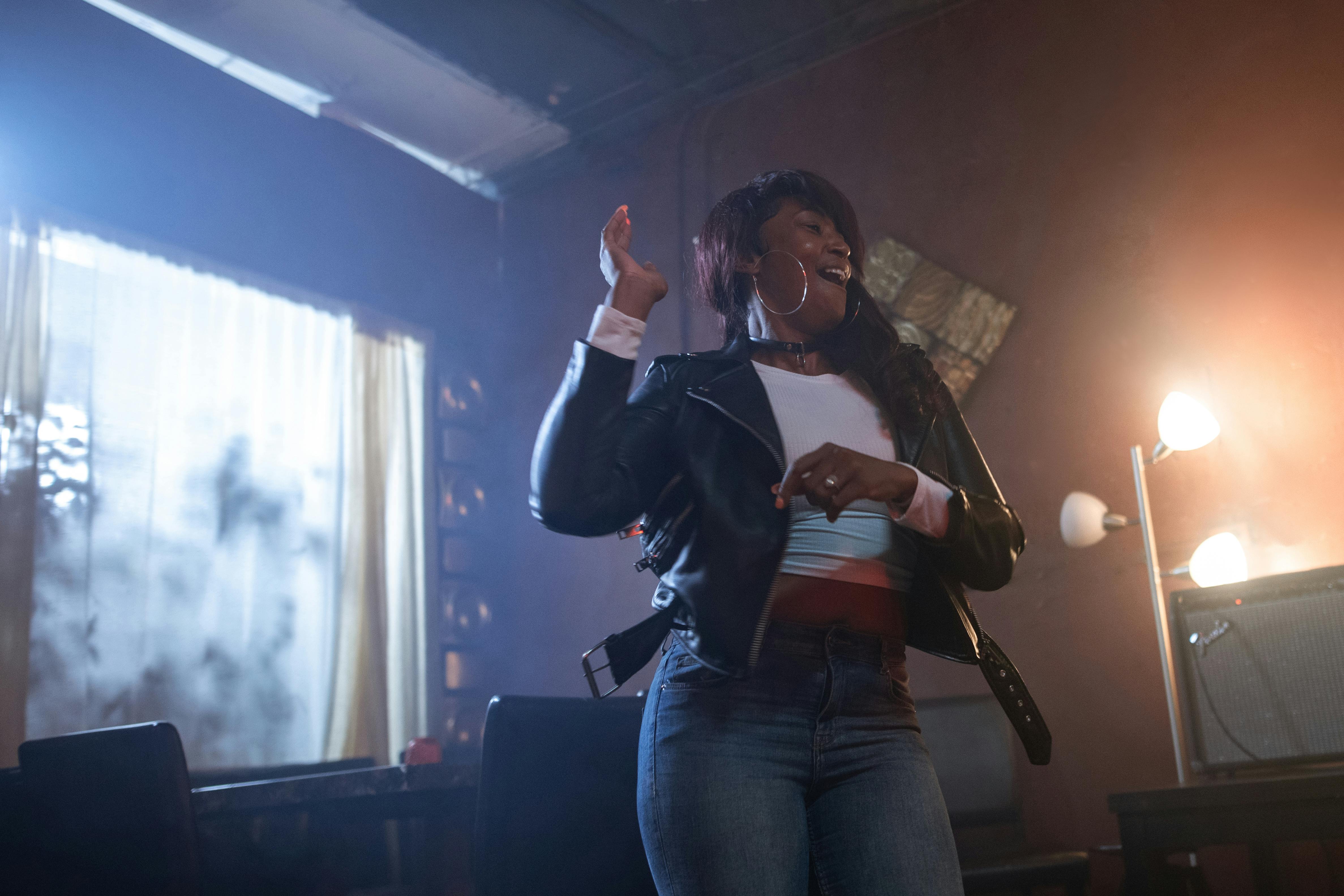 A Woman in Black Leather Jacket and Denim Jeans Dancing · Free Stock Photo