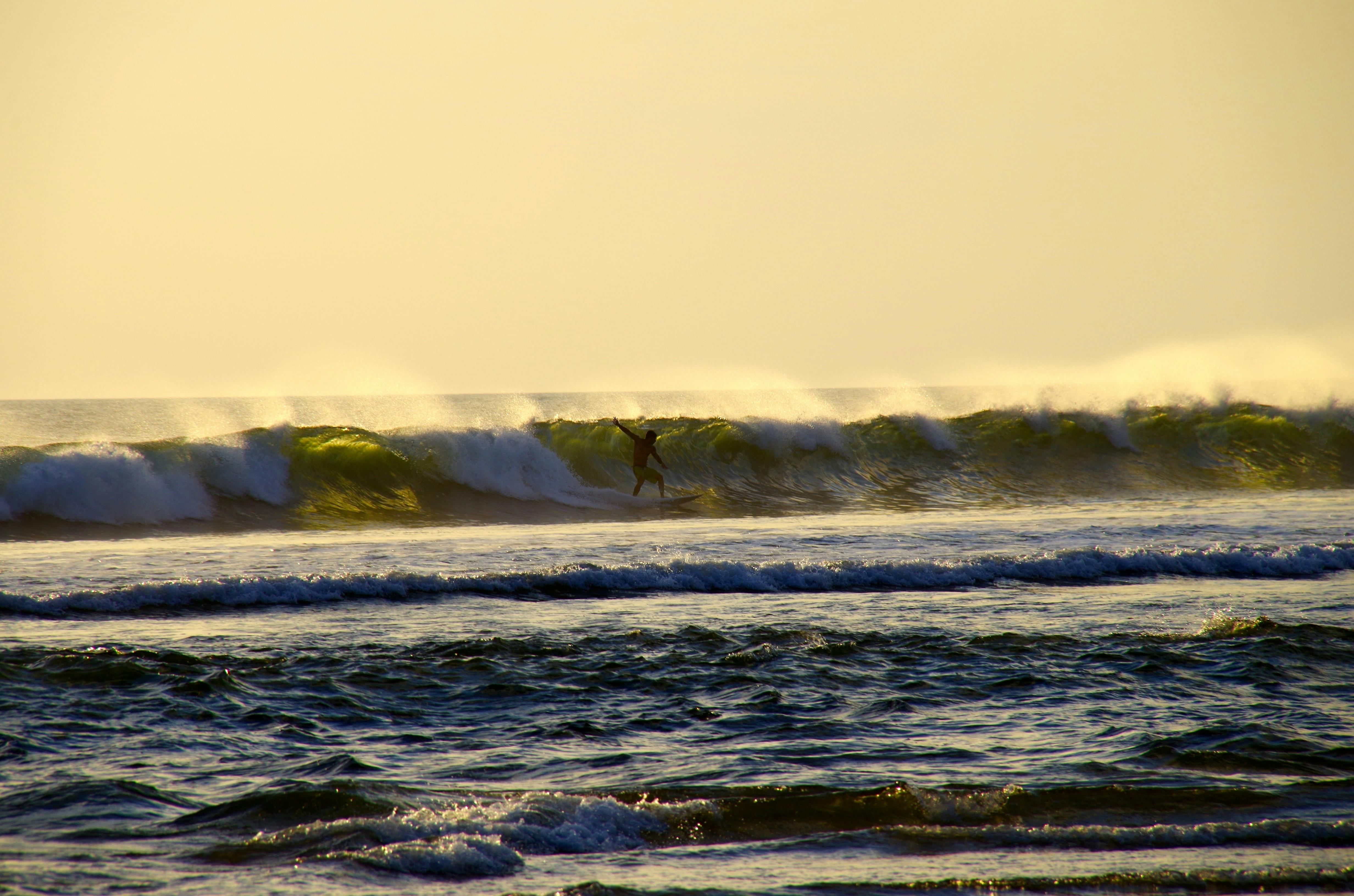 Photo of Sea Wave Crashing with People Swimming · Free Stock Photo
