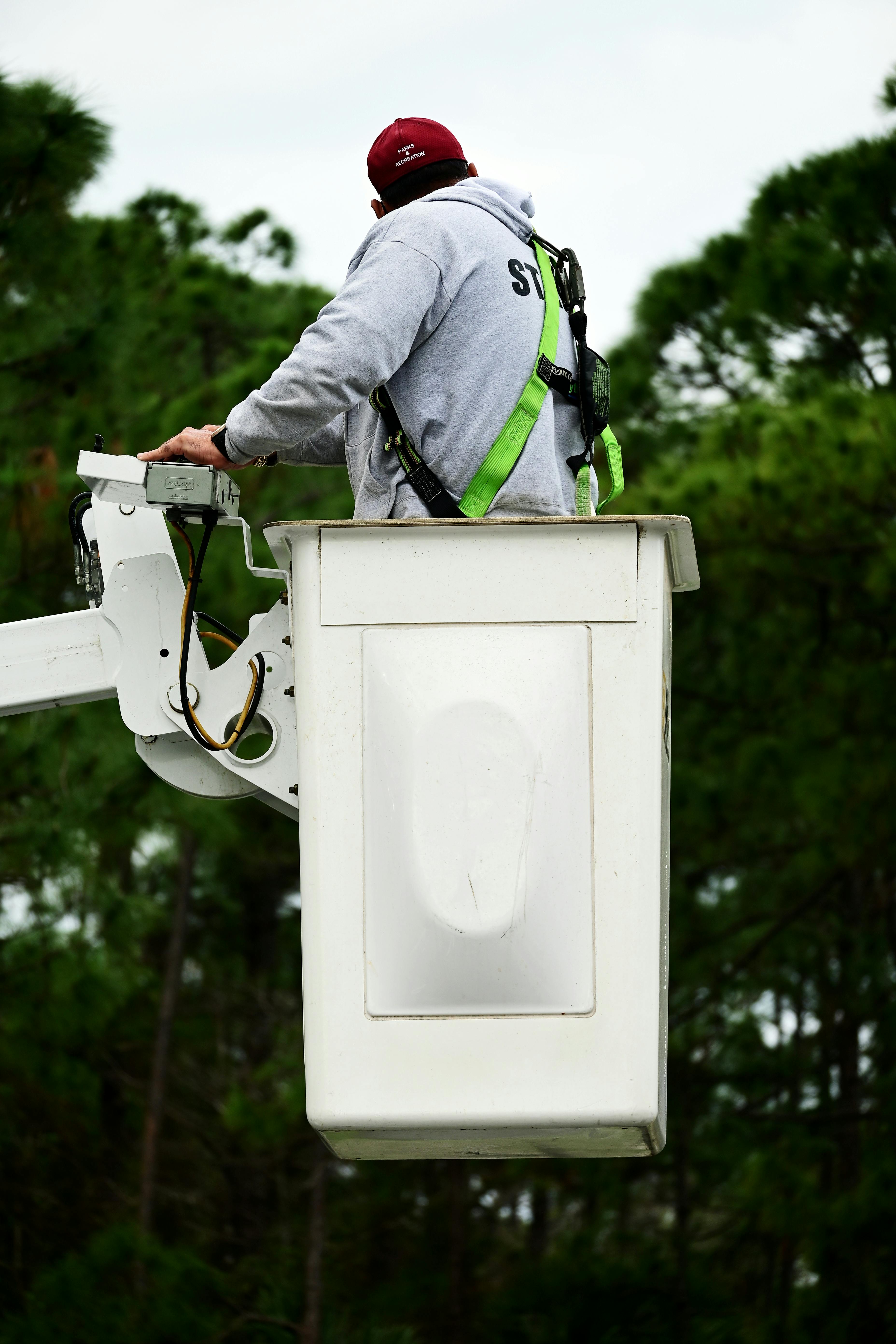 Man in Bucket Lift Outdoors · Free Stock Photo