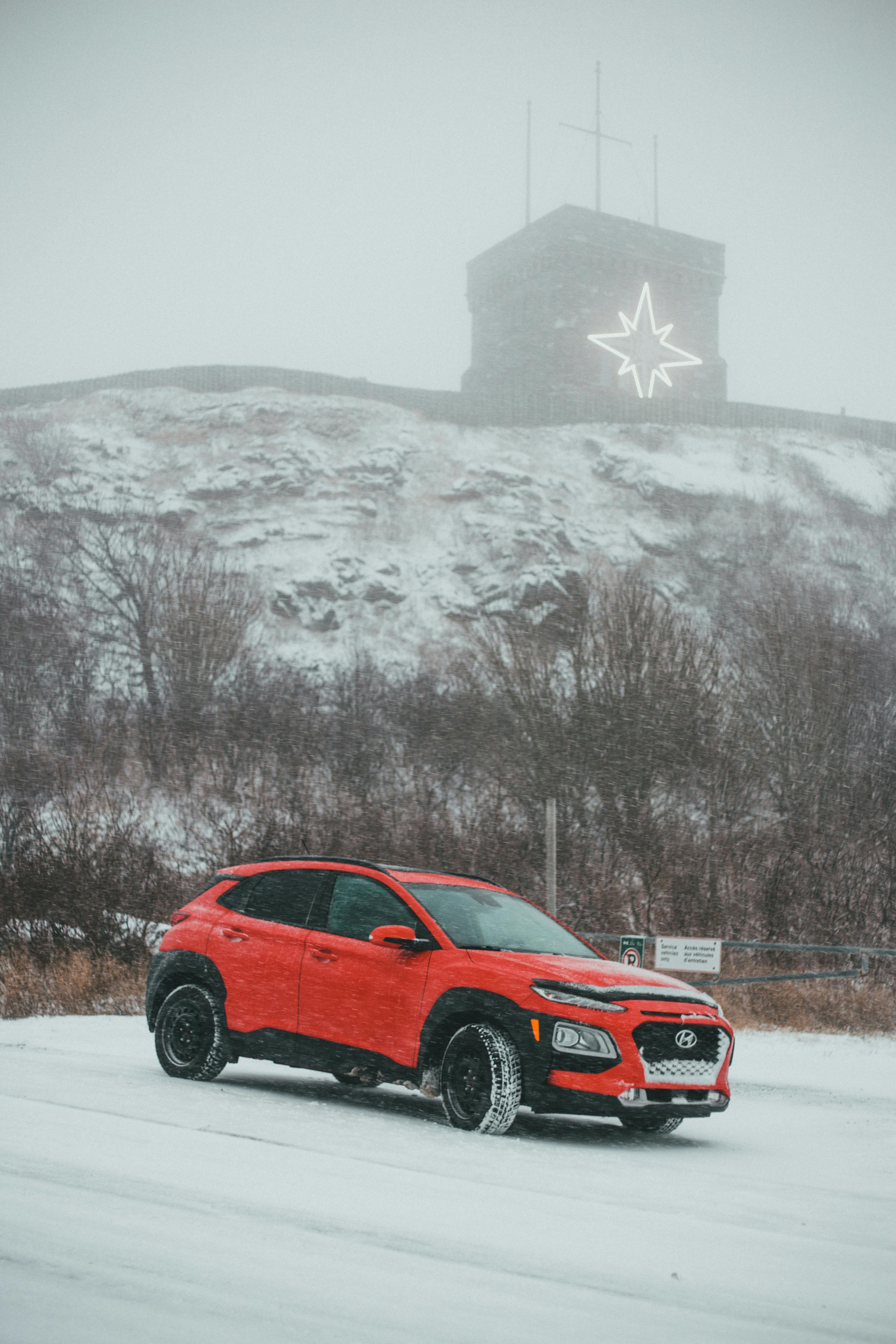 A Red Car Parked on the Snow · Free Stock Photo