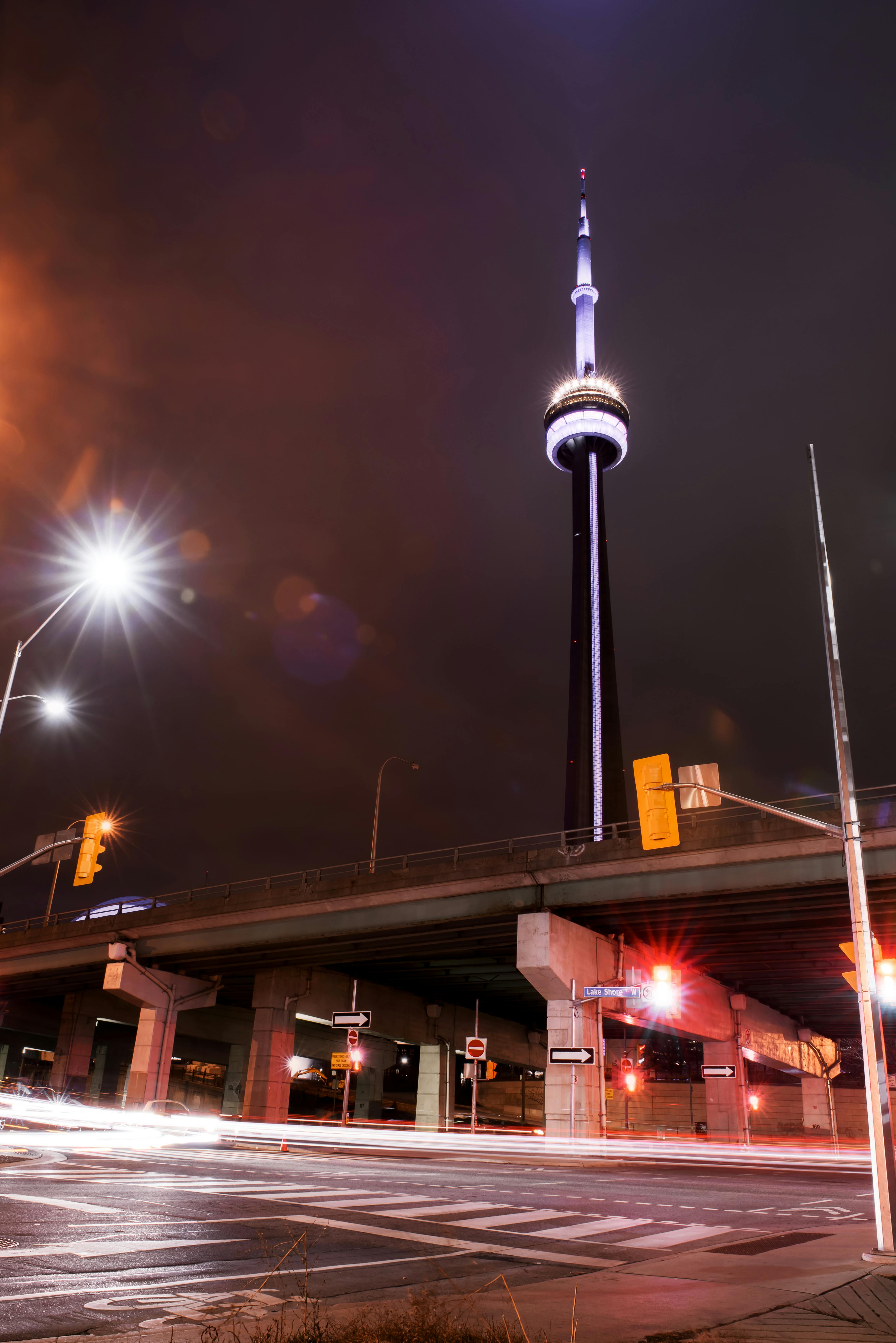 Modern illuminated high tower near bridge · Free Stock Photo