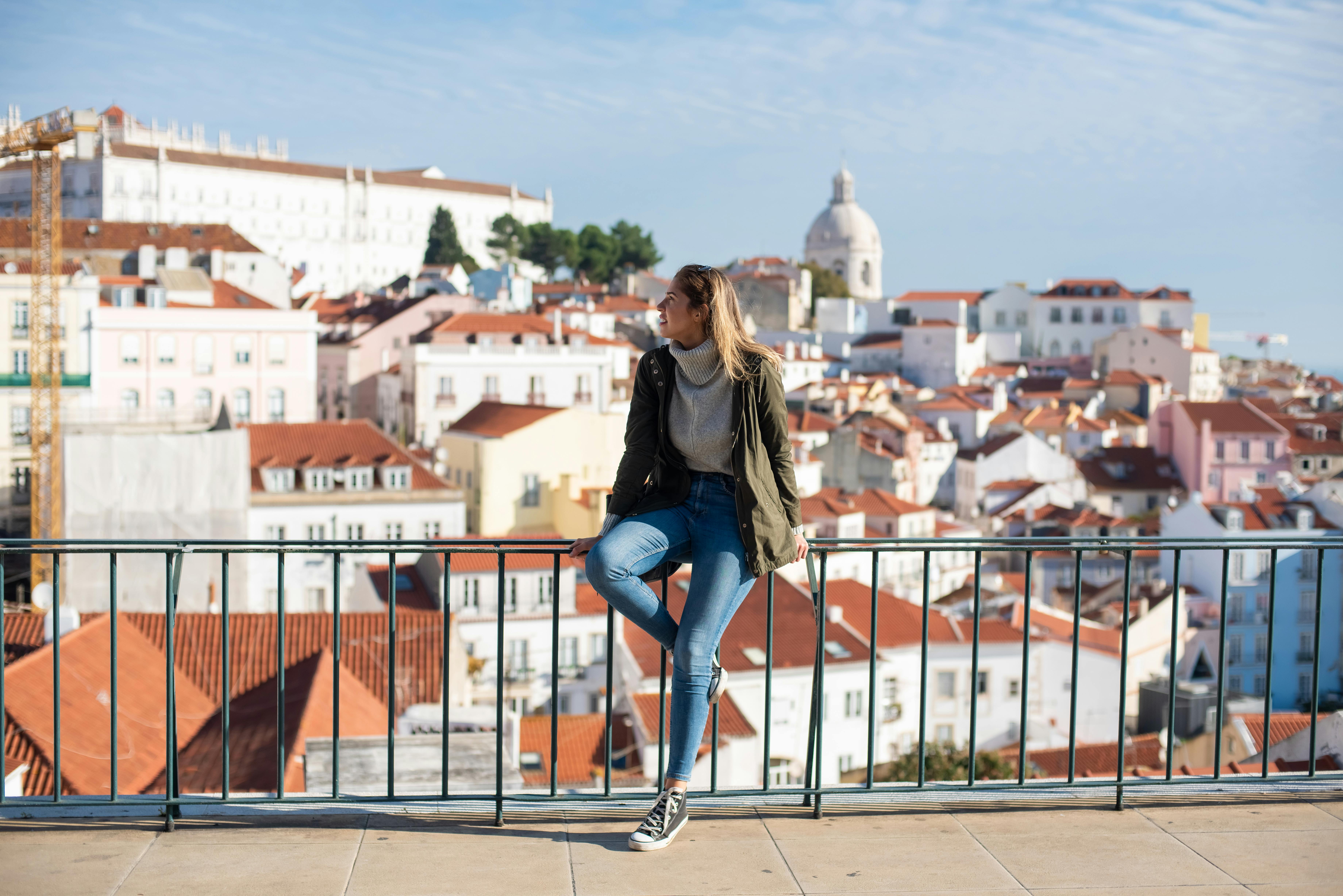 A Woman Sitting on the Metal Railings · Free Stock Photo