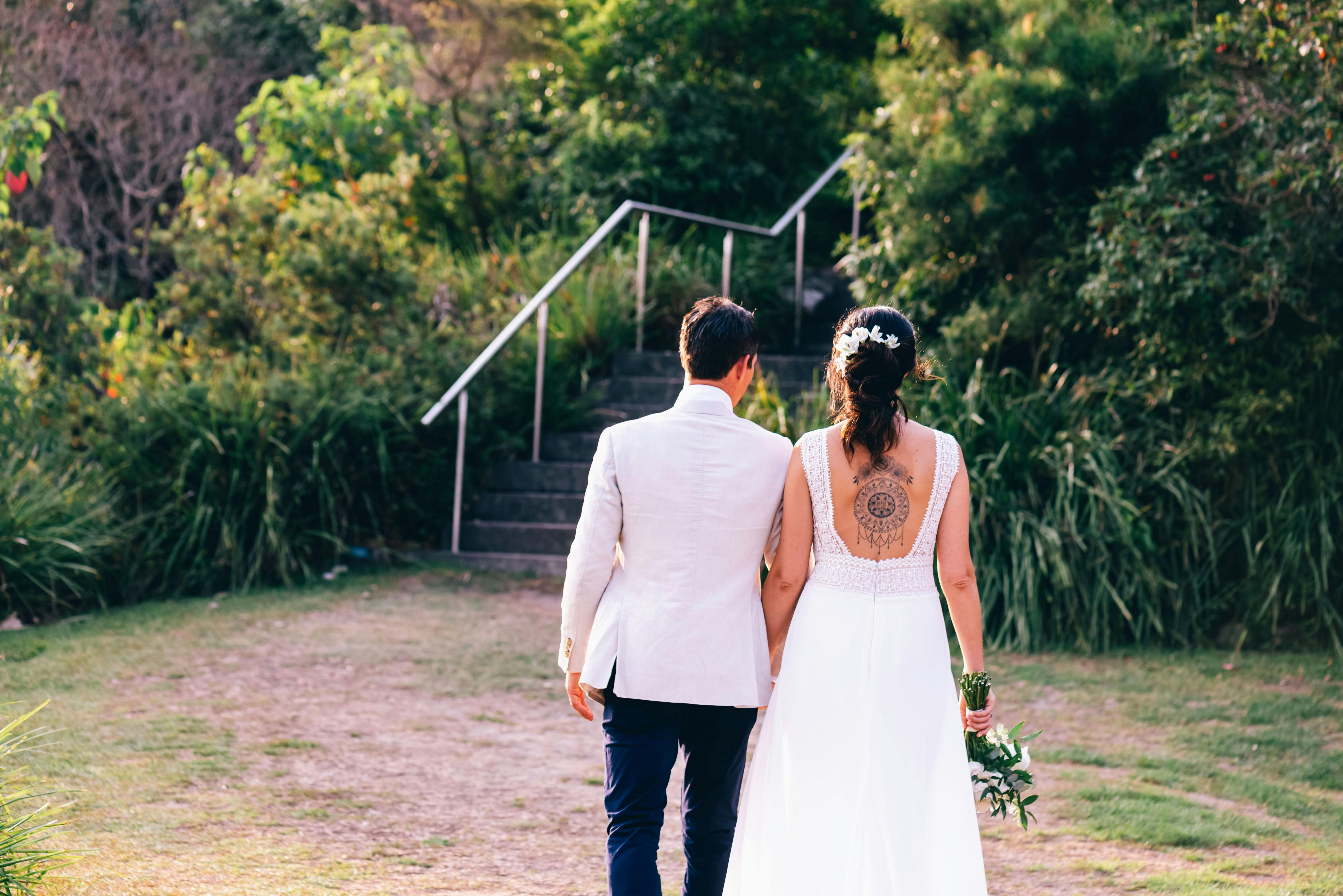 A Back View of a Bride and Groom Standing Together · Free Stock Photo