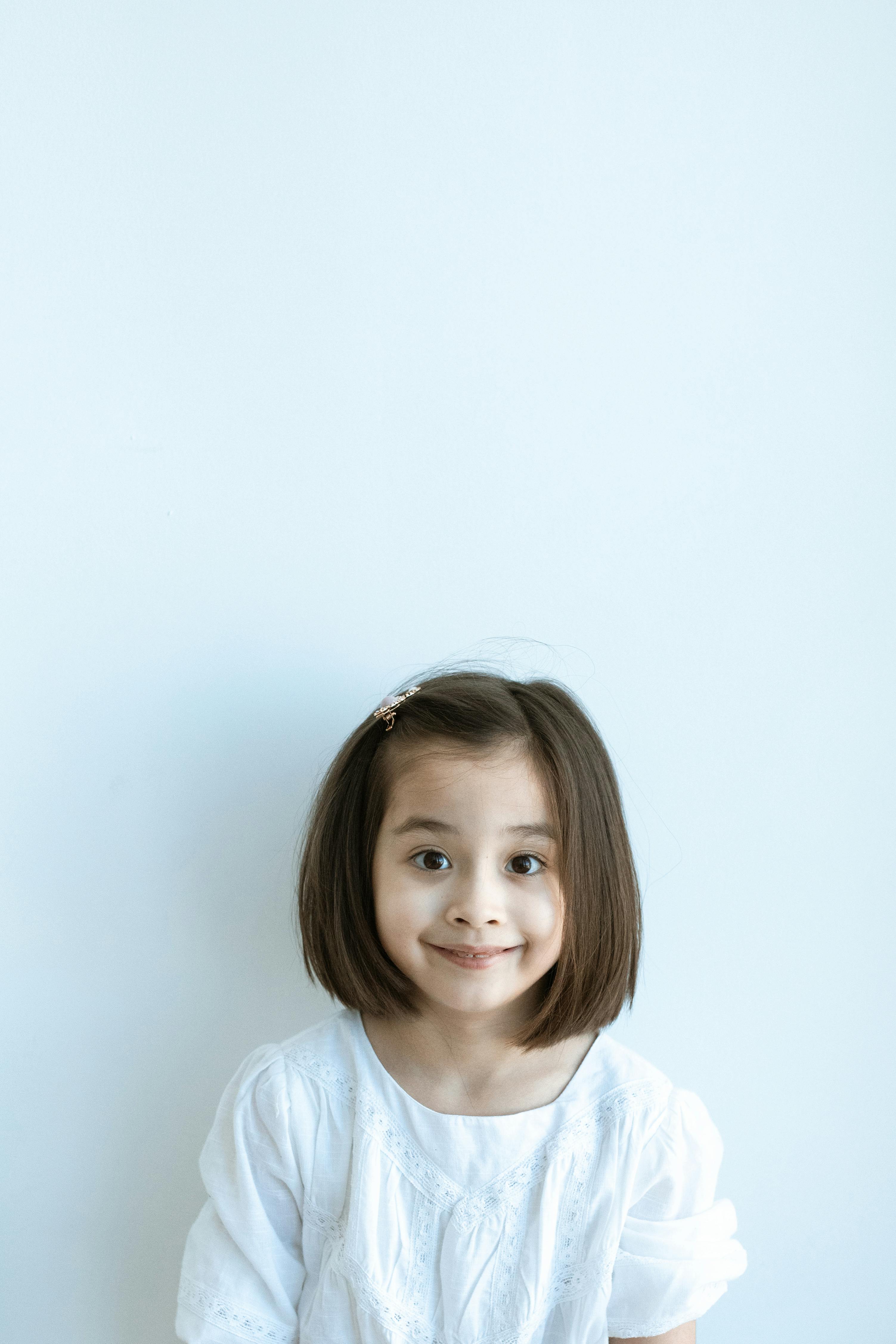 Little Girl Hiding her Face in a White Dress · Free Stock Photo