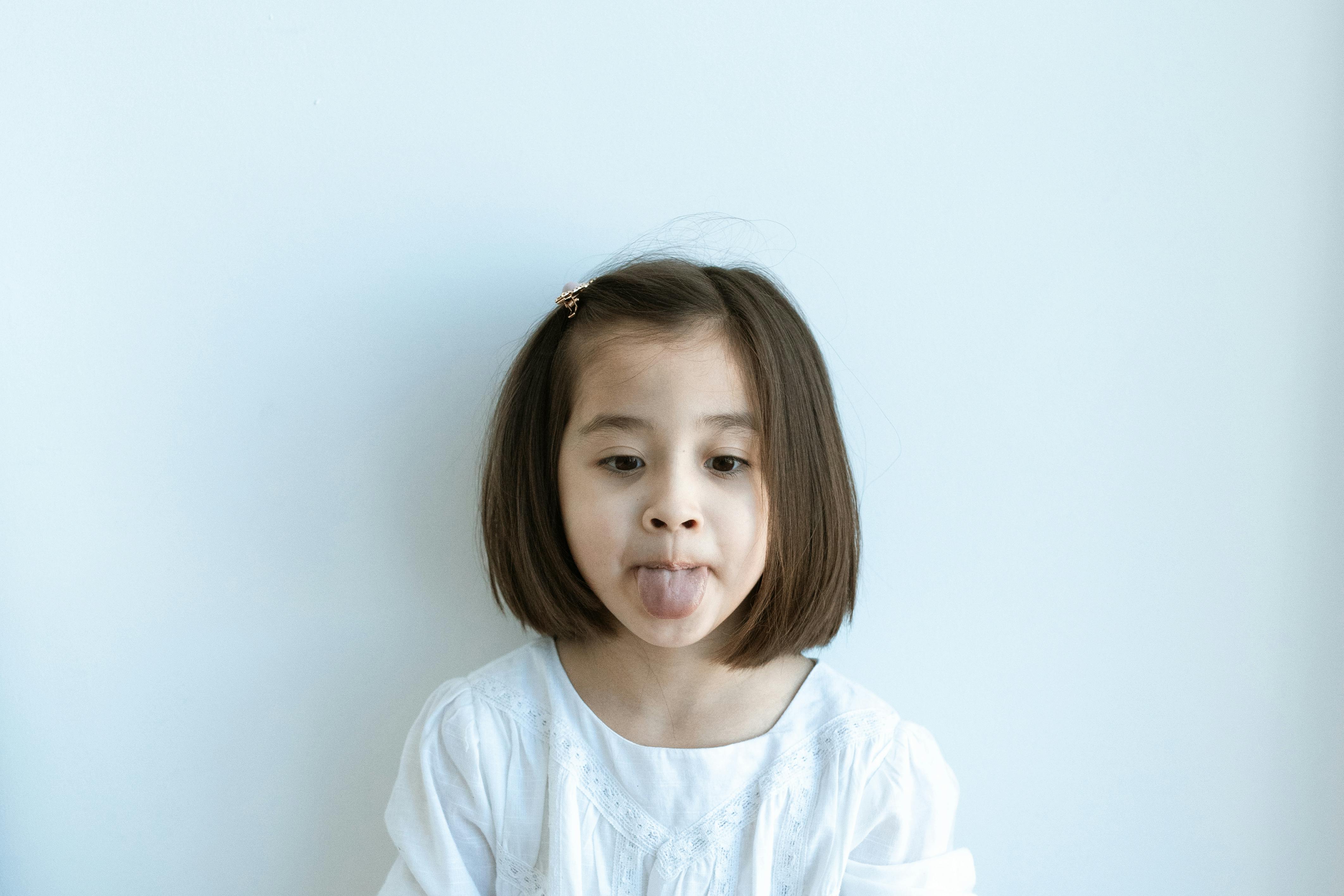 Adorable Child with her Tongue Out · Free Stock Photo