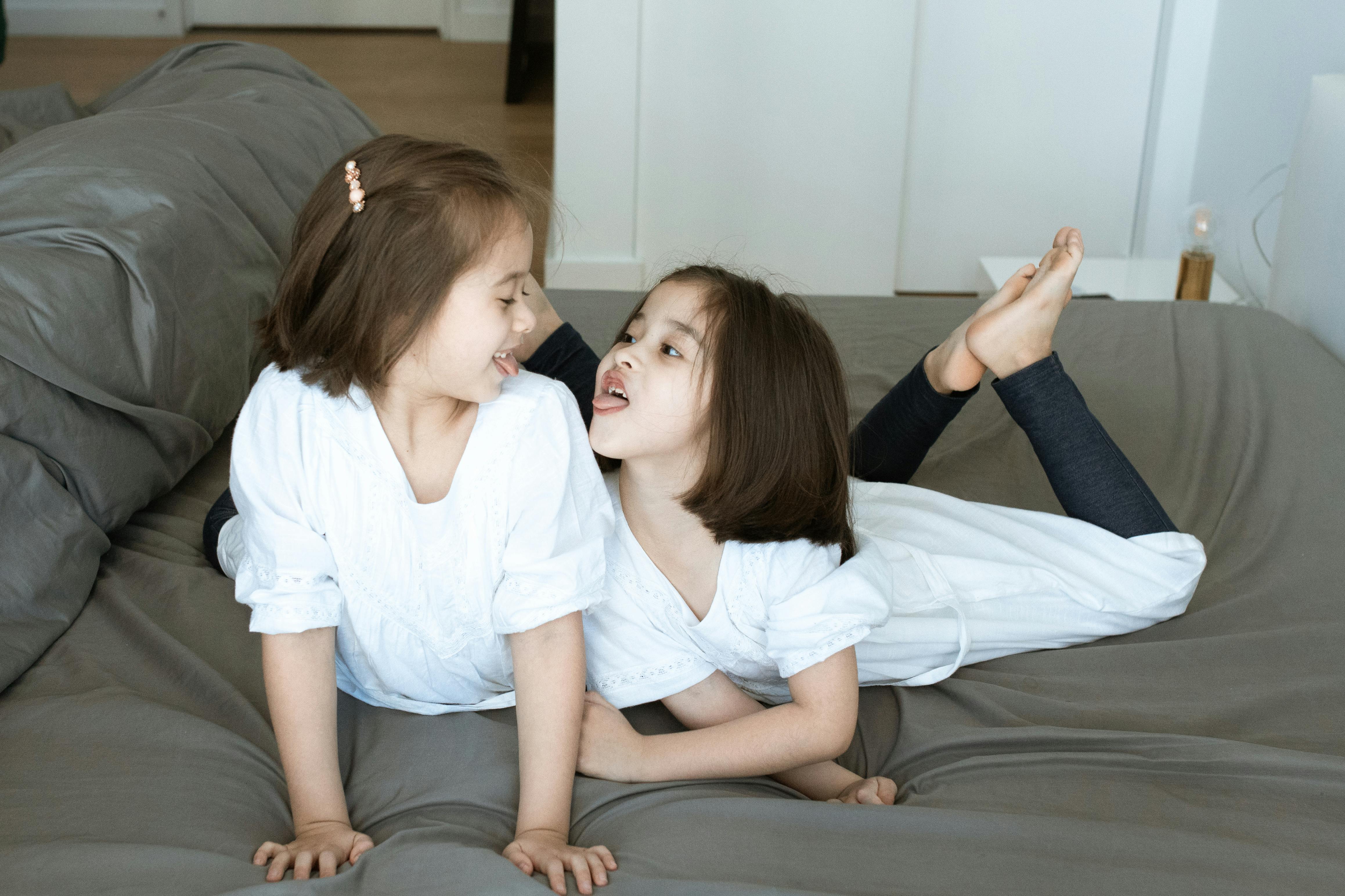 Selective Focus Photo of Little Girl Lying Forward on the Bed · Free ...