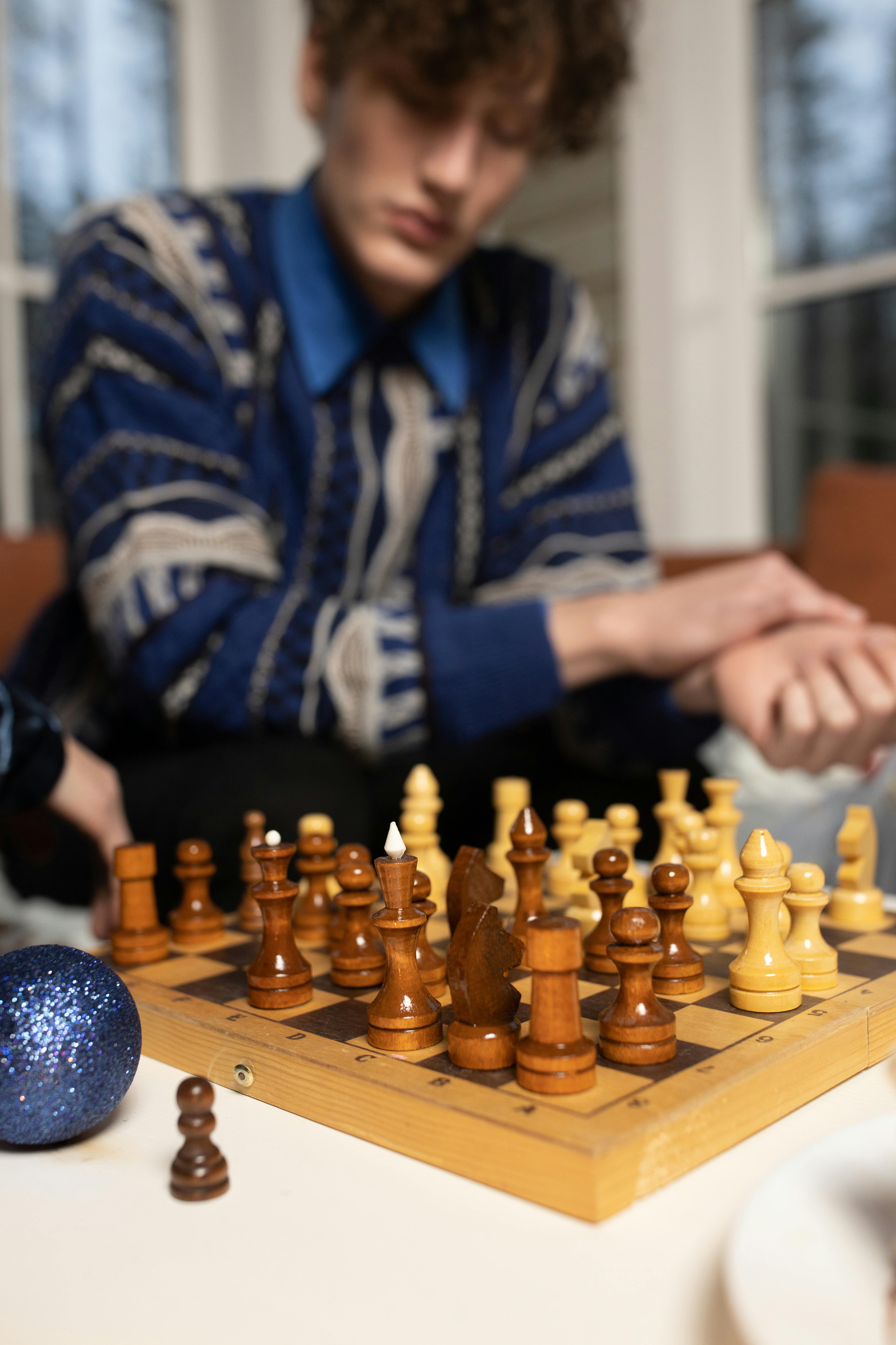 Close-Up Shot of a Person Playing Chess · Free Stock Photo