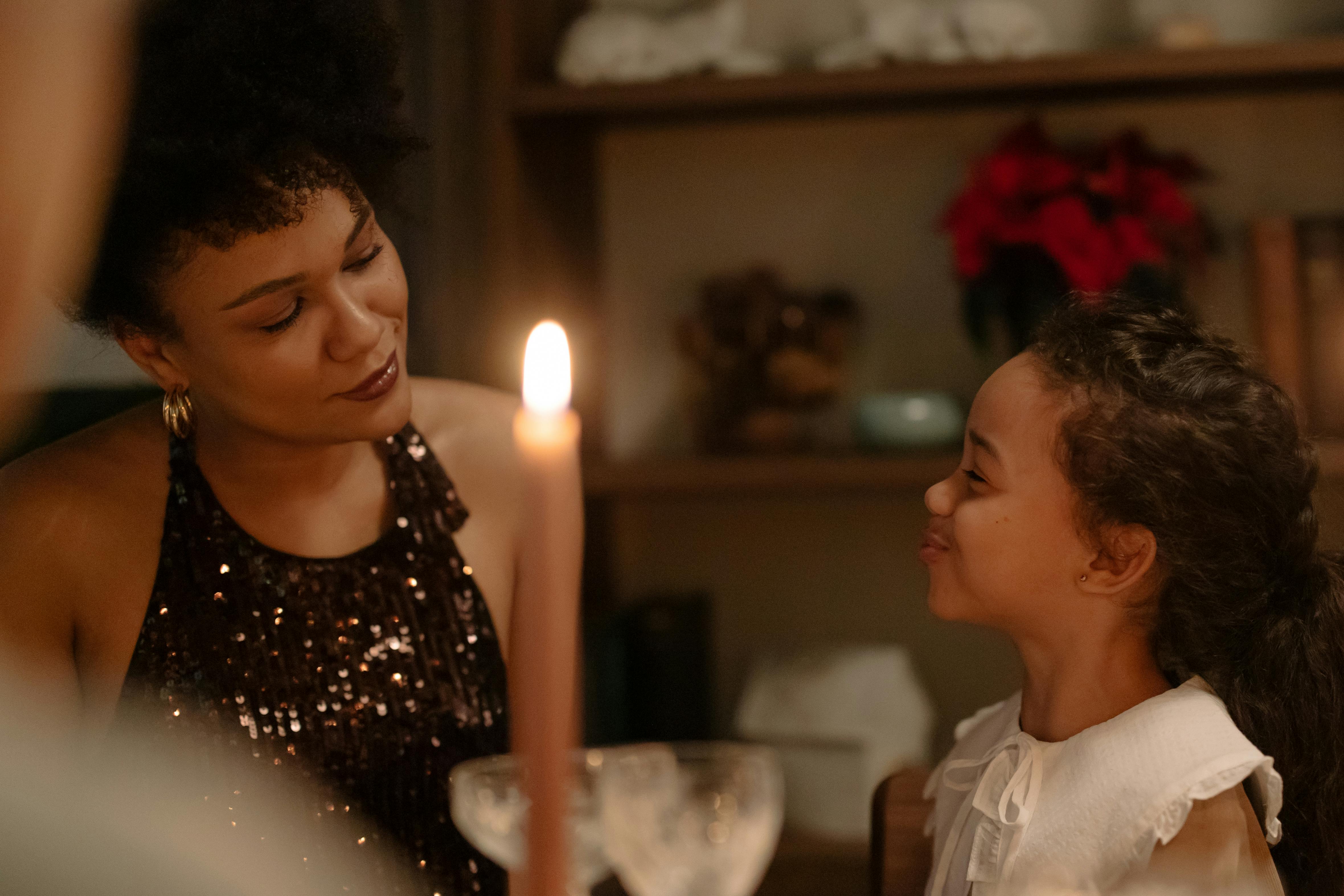 A Cute Girl Making a Funny Face in front of Her Mother · Free Stock Photo