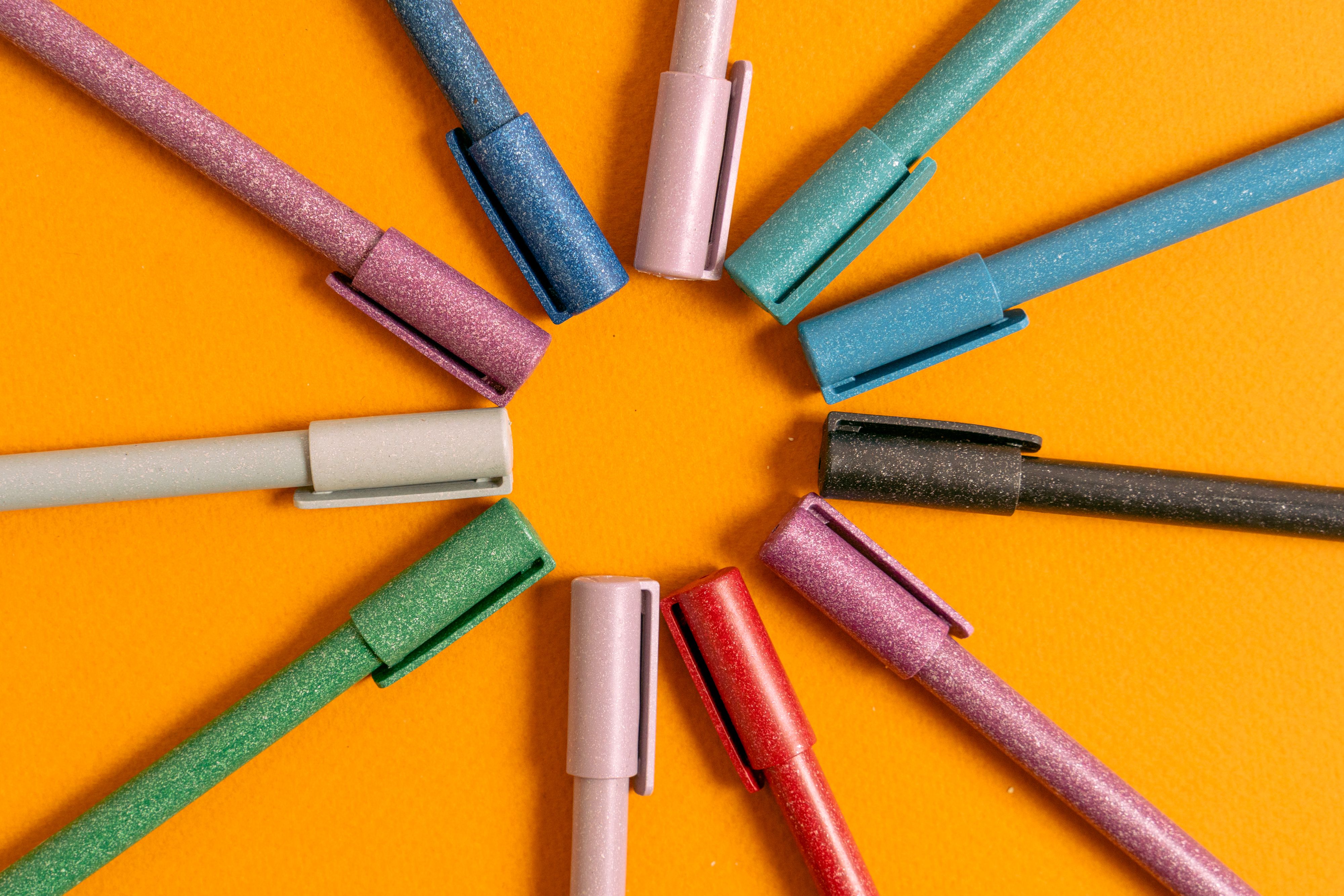 Colorful Pens on Orange Background · Free Stock Photo