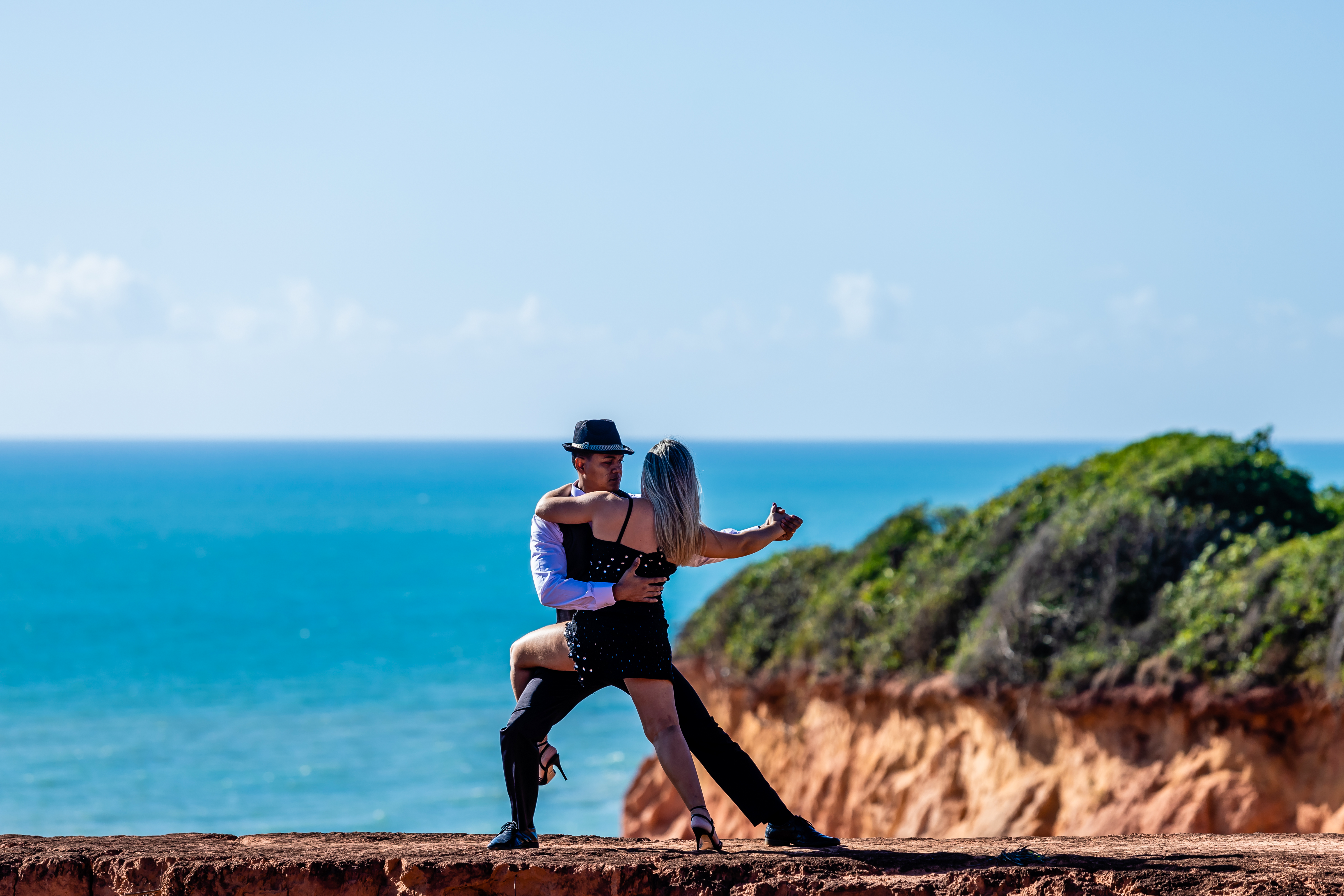 A Couple Dancing on a Ledge with a Beautiful Scenery · Free Stock Photo