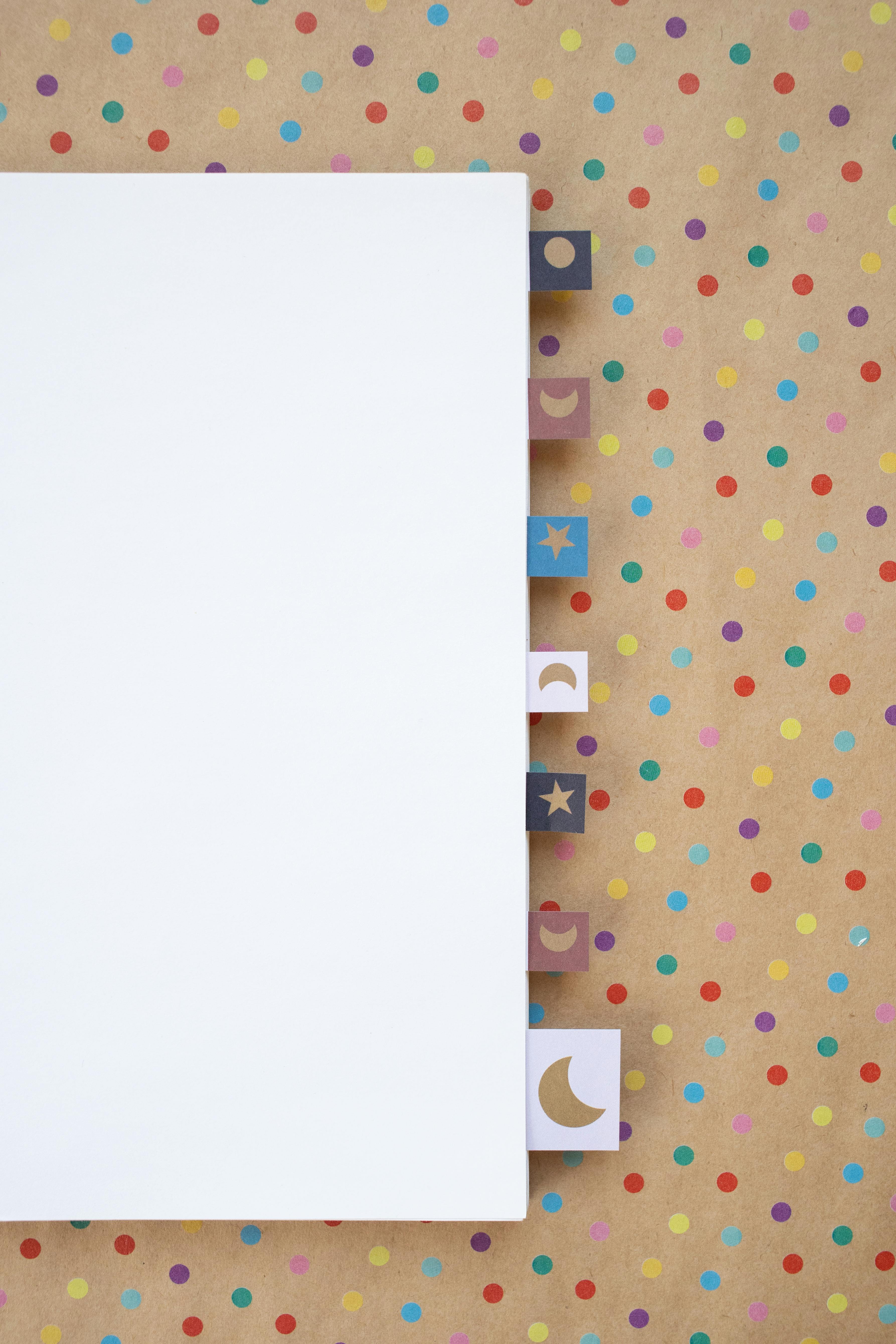 White Notebook and Pen on Polka Dots Background · Free Stock Photo