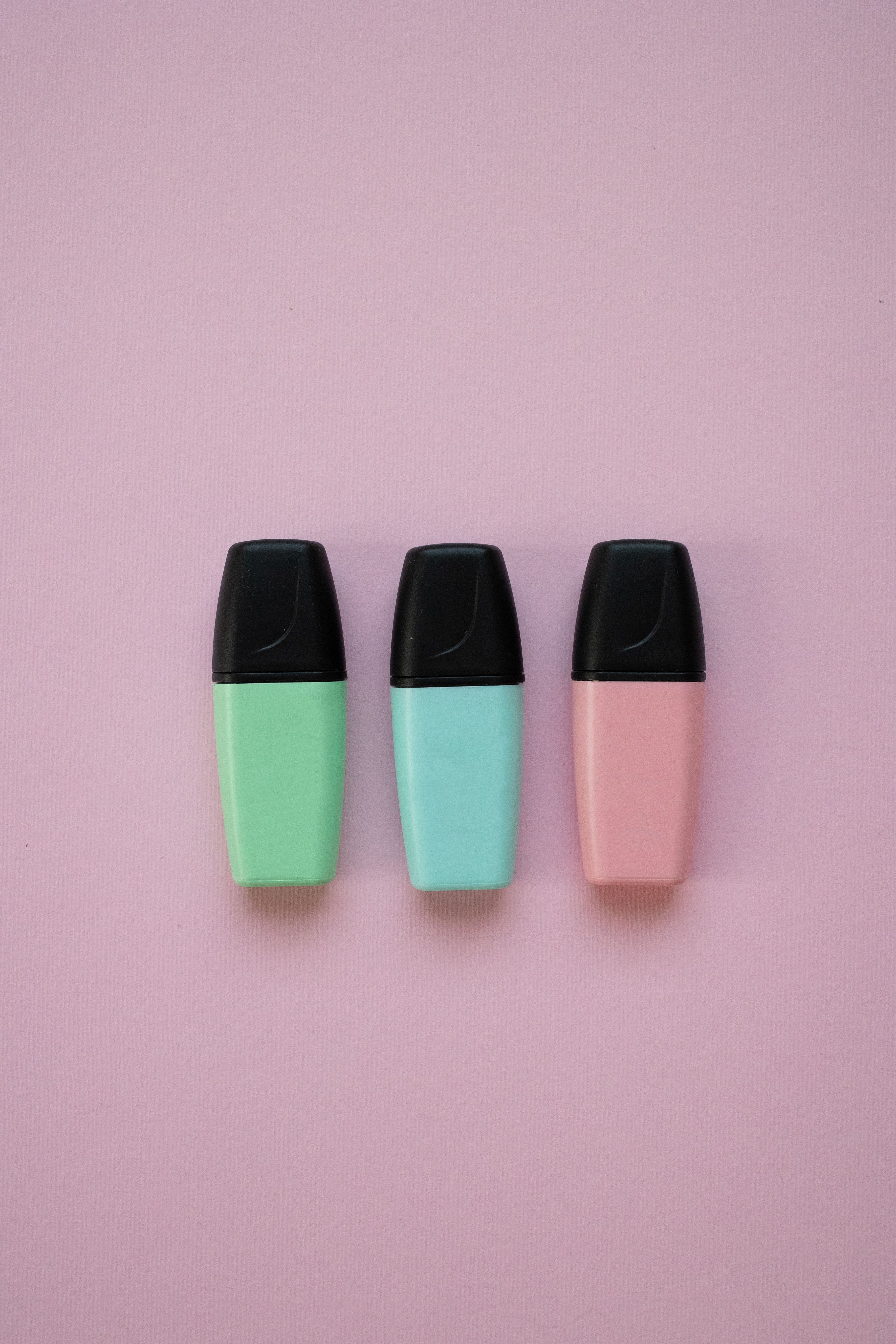 Colored Markers on a Pink Surface · Free Stock Photo