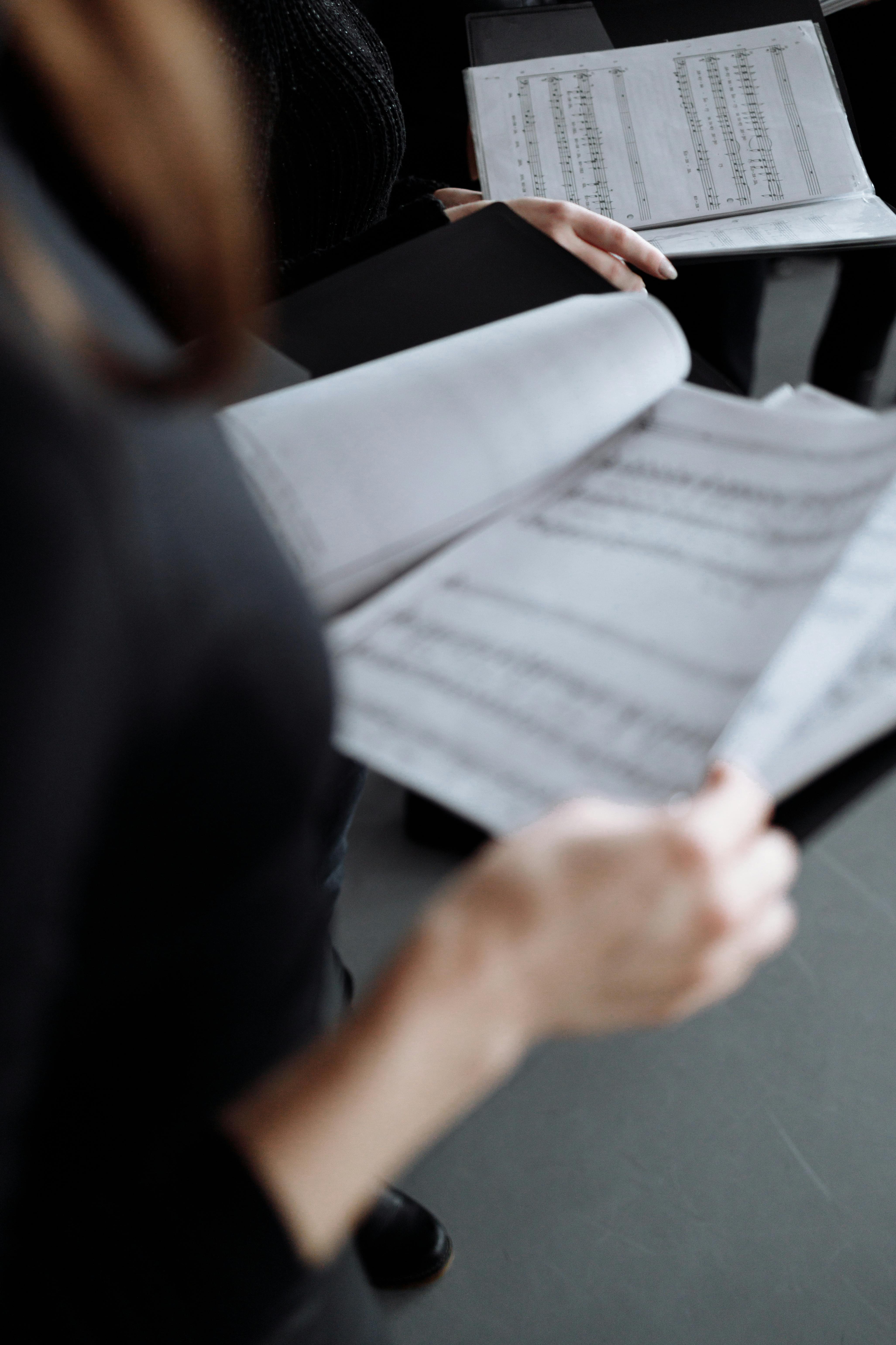 Person Holding Music Notes on Piano · Free Stock Photo